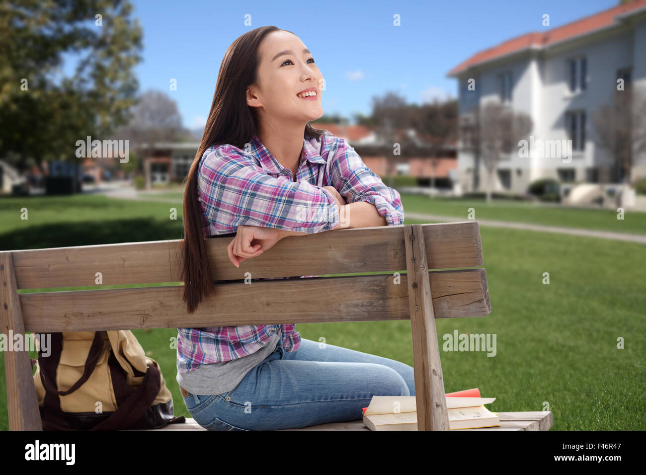 Portrait of college student sitting on bench Stock Photo - Alamy