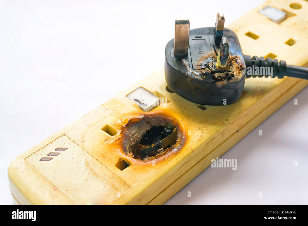 Fire in overloaded power strip isolated white background Stock Photo ...