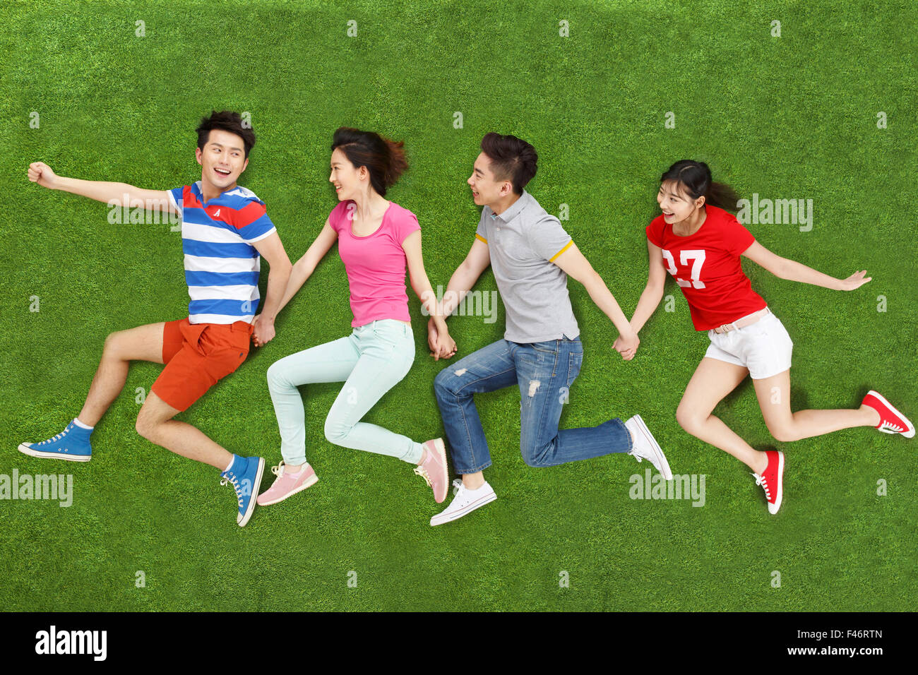Young people on grass Stock Photo - Alamy