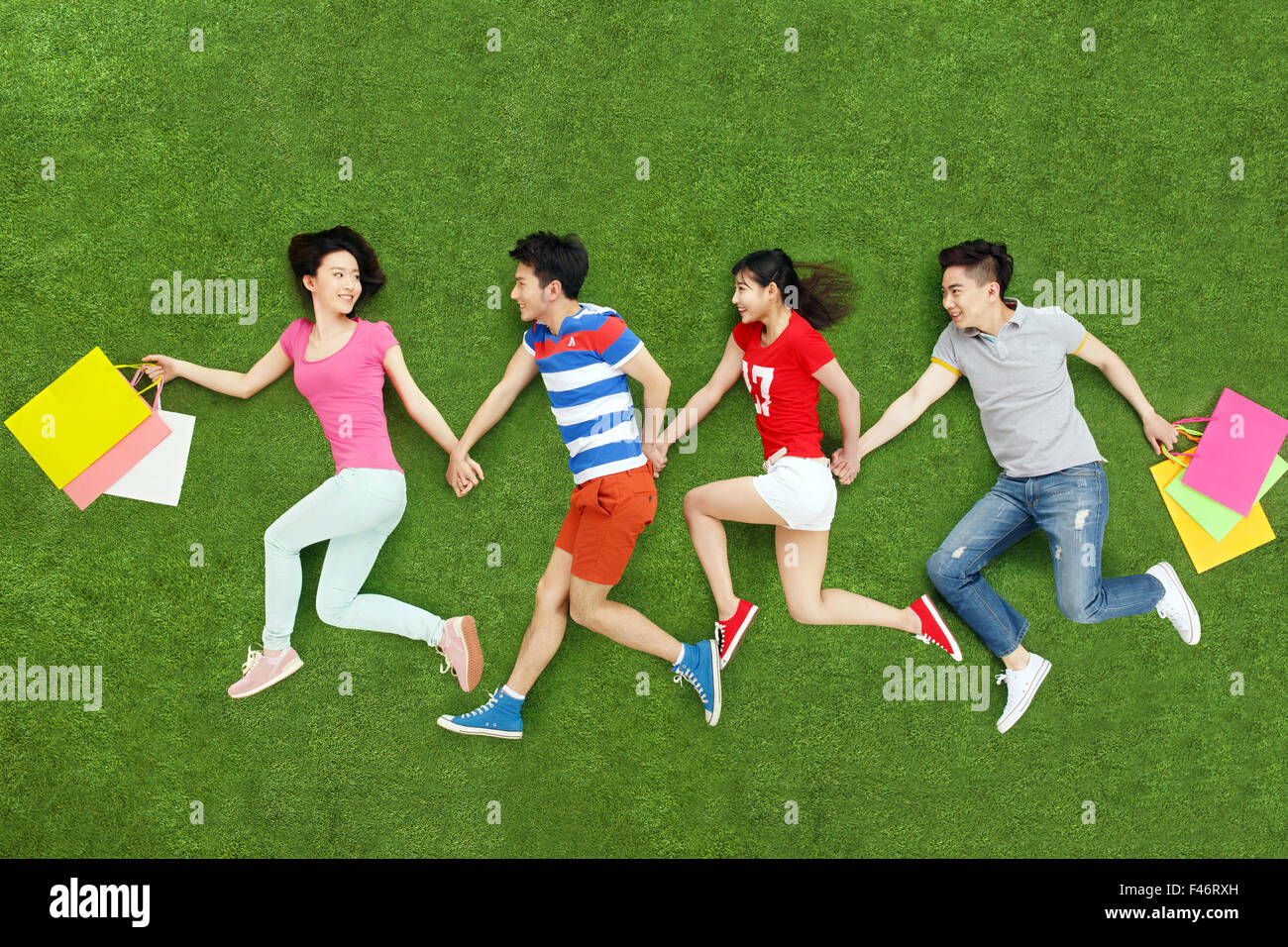 Young people on grass Stock Photo - Alamy