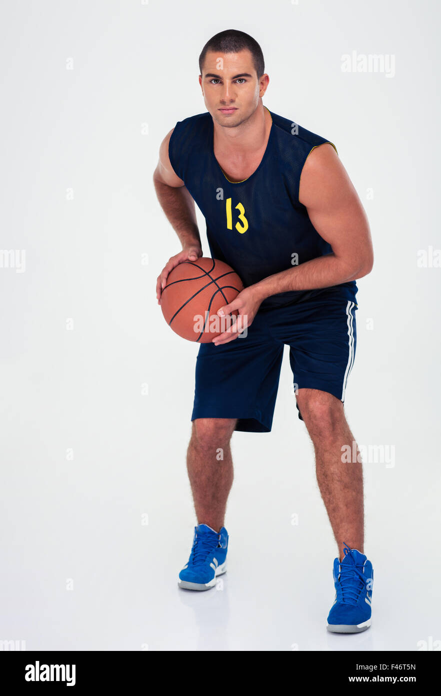 Full length portrait of a man playing in basketball isolated on a white ...
