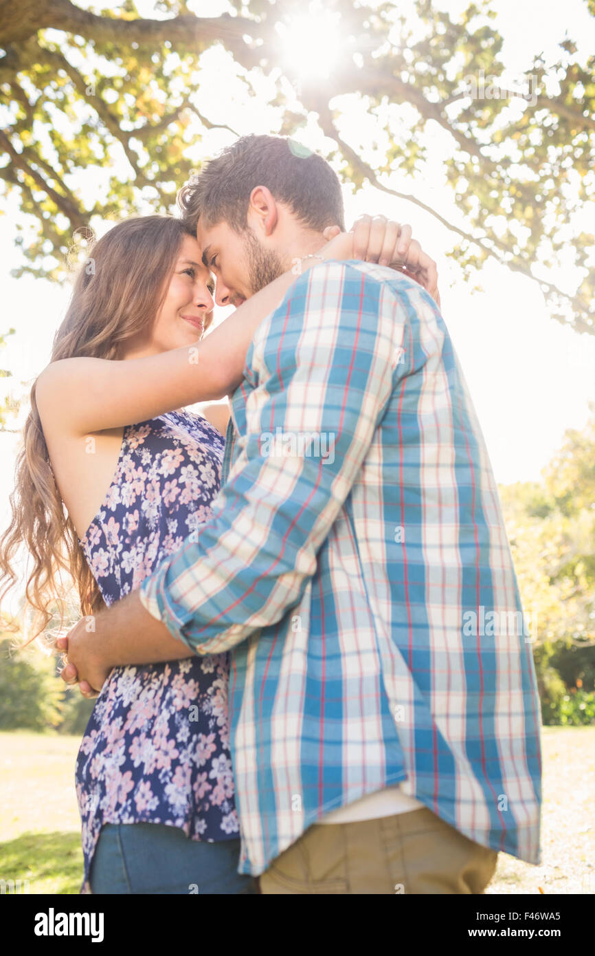 Cute couple hugging in the park Stock Photo - Alamy
