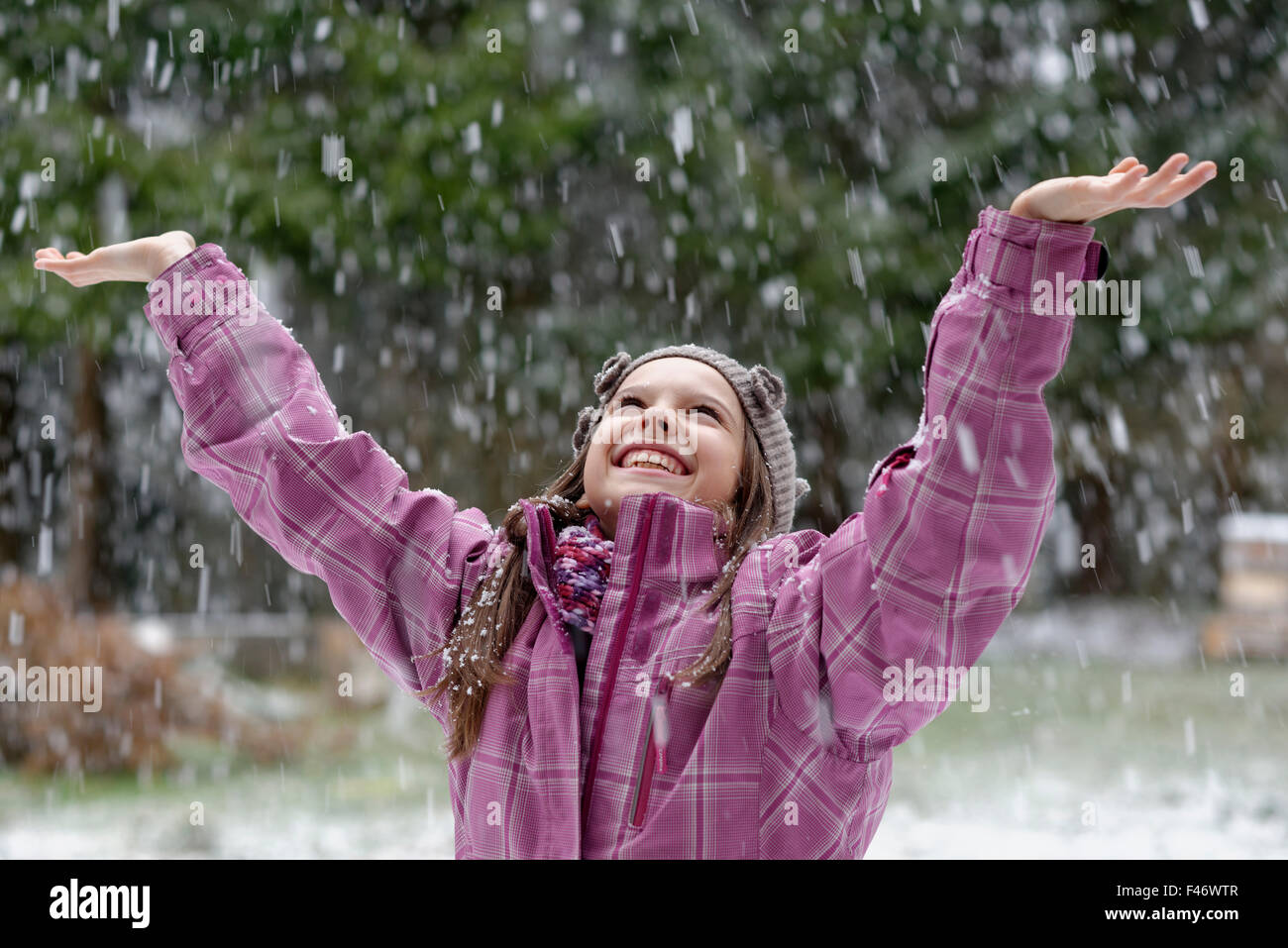Girl enjoying the snowfall, beginning of winter, Upper Bavaria, Bavaria ...