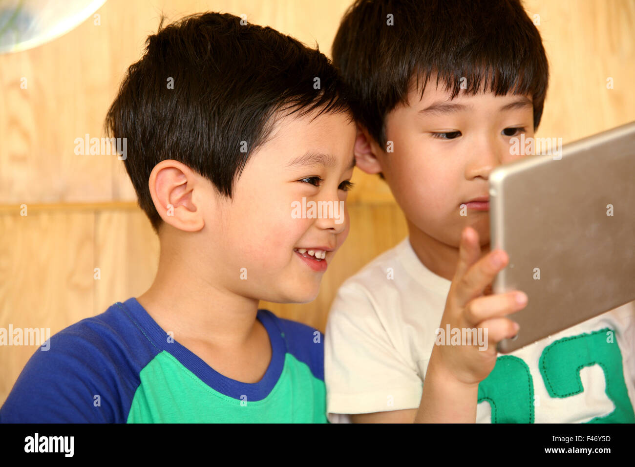 Two boys using digital tablet Stock Photo - Alamy