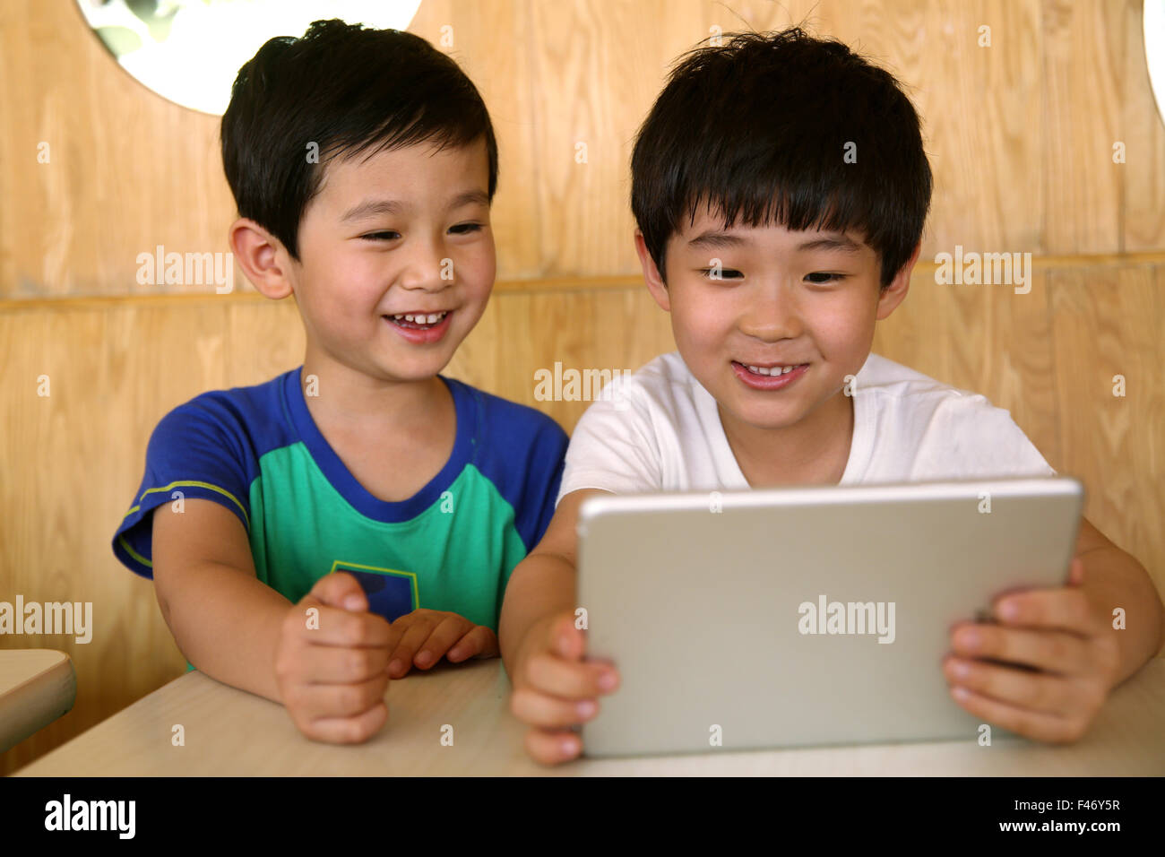 Two boys using digital tablet Stock Photo - Alamy