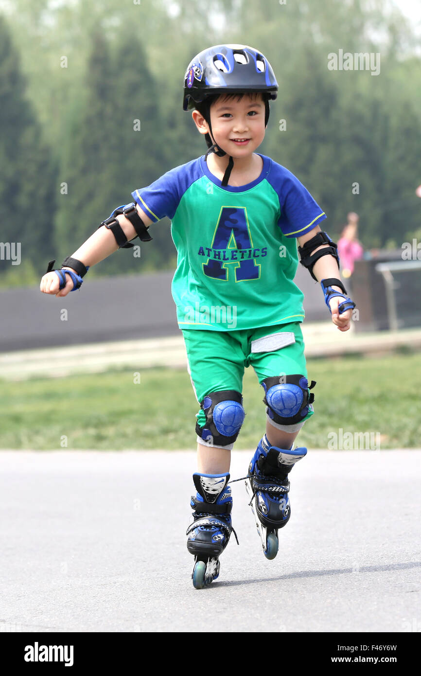 Boy inline skating outdoors Stock Photo - Alamy