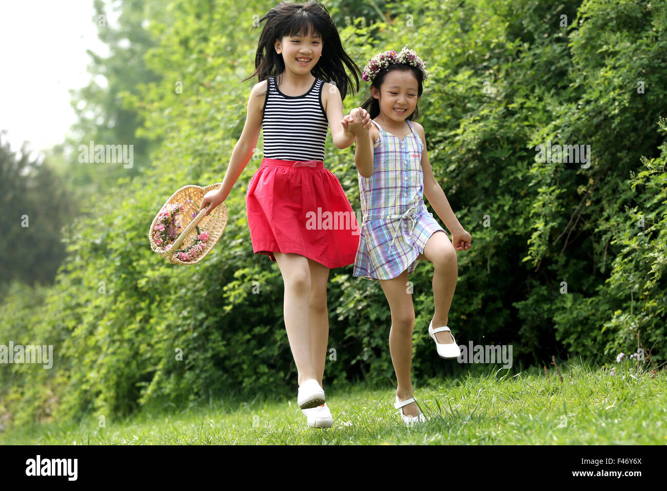 Two girls playing in field Stock Photo - Alamy