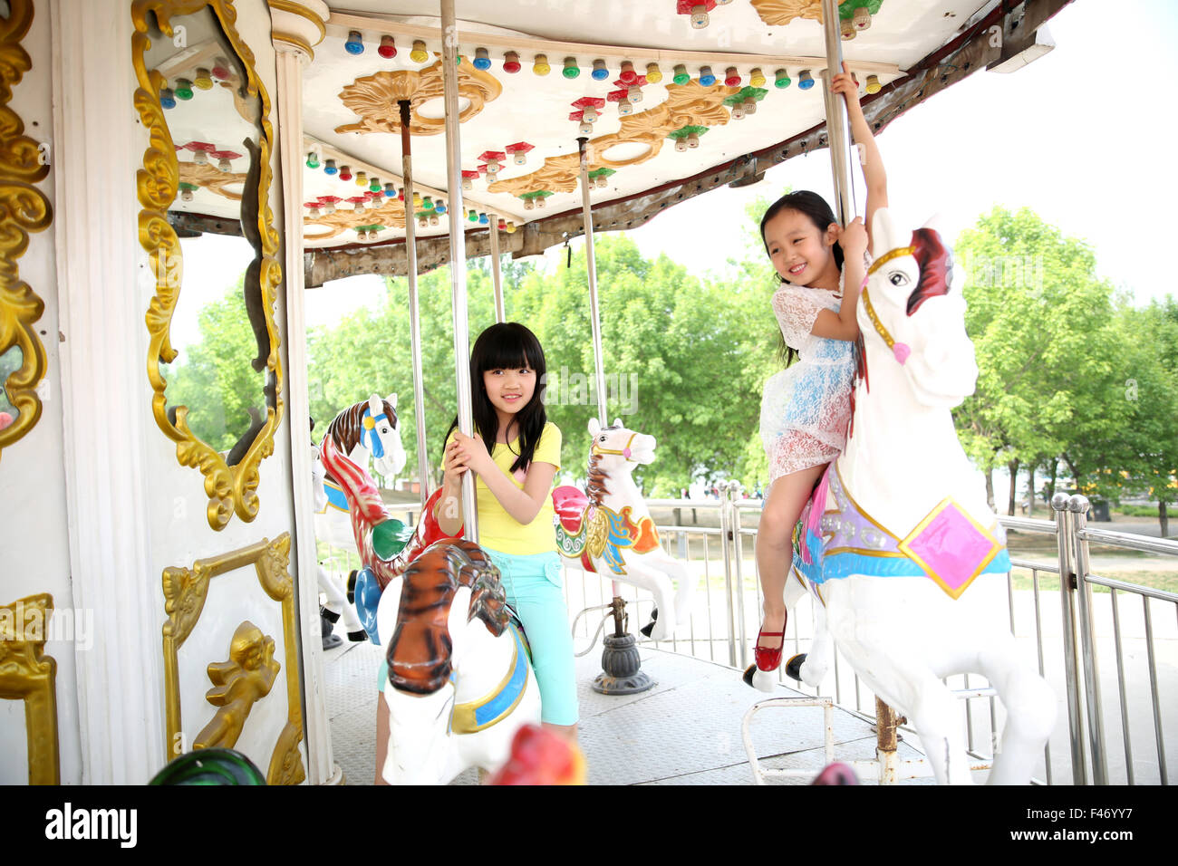 Two girls on carousel hi-res stock photography and images - Alamy