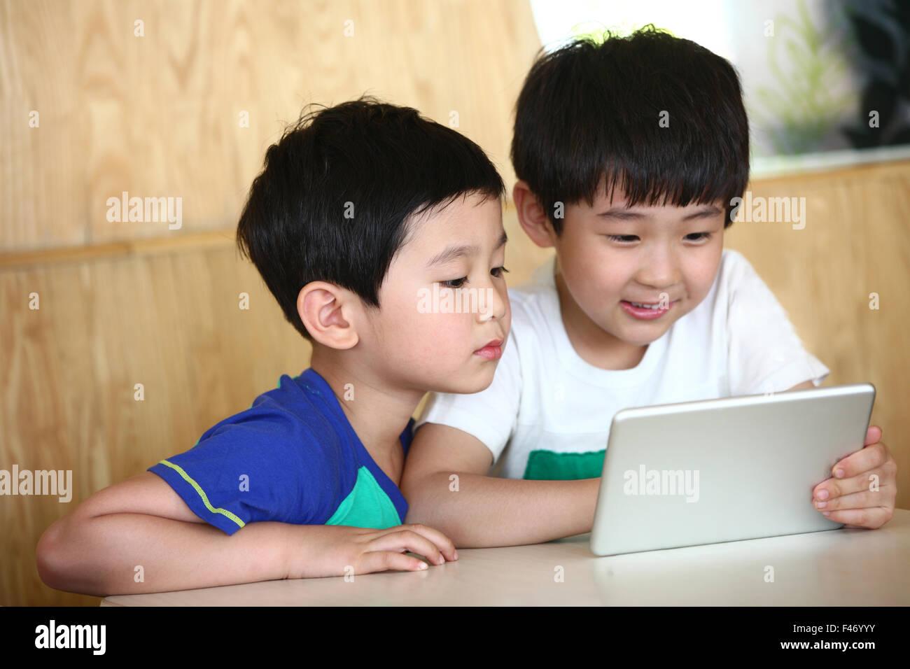 Two boys using digital tablet Stock Photo - Alamy