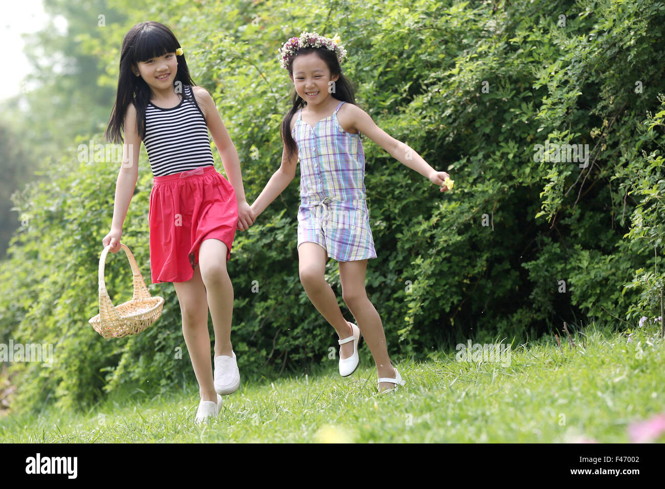 Two girls playing in field Stock Photo - Alamy