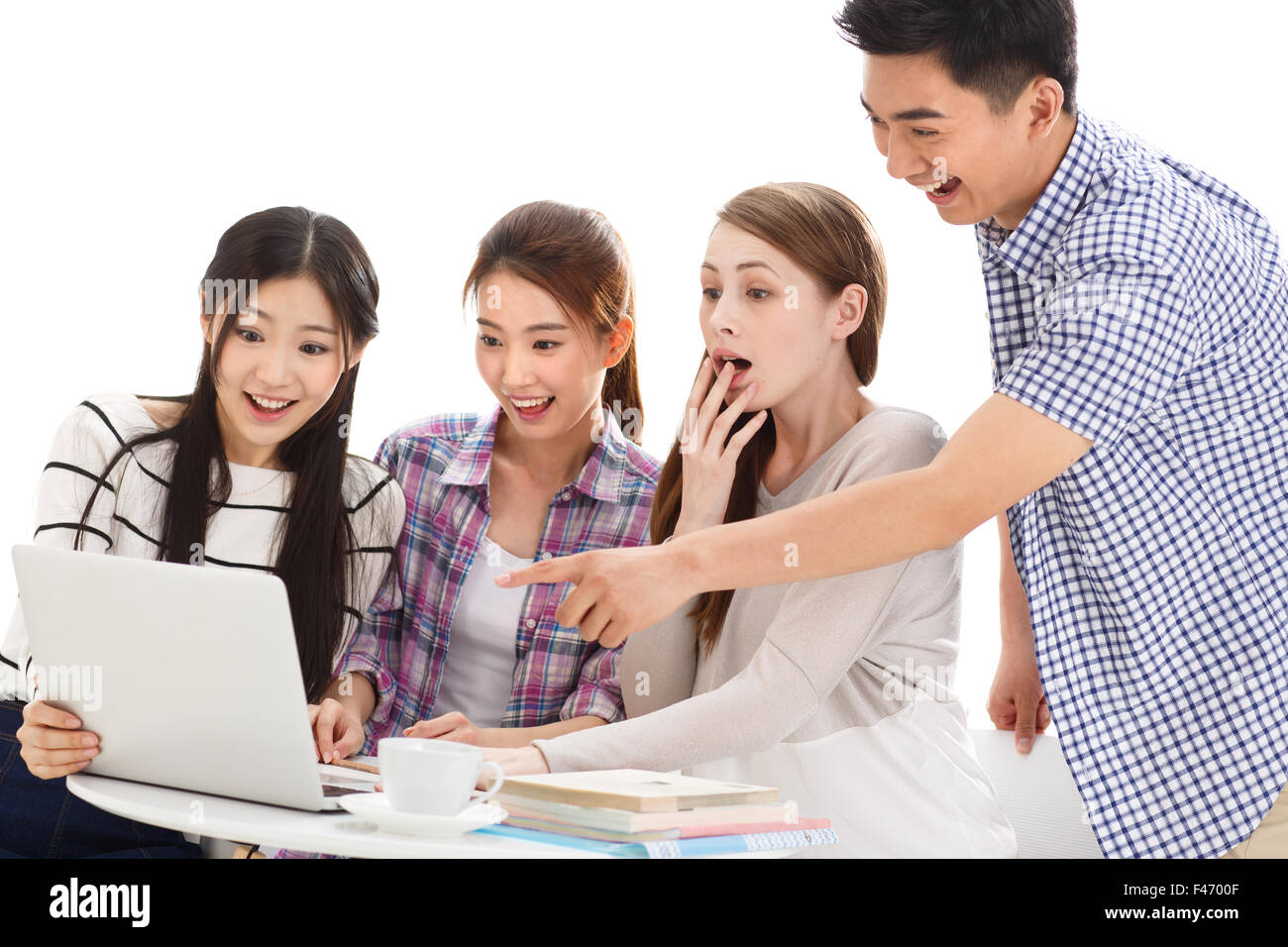 Young people around table Stock Photo - Alamy