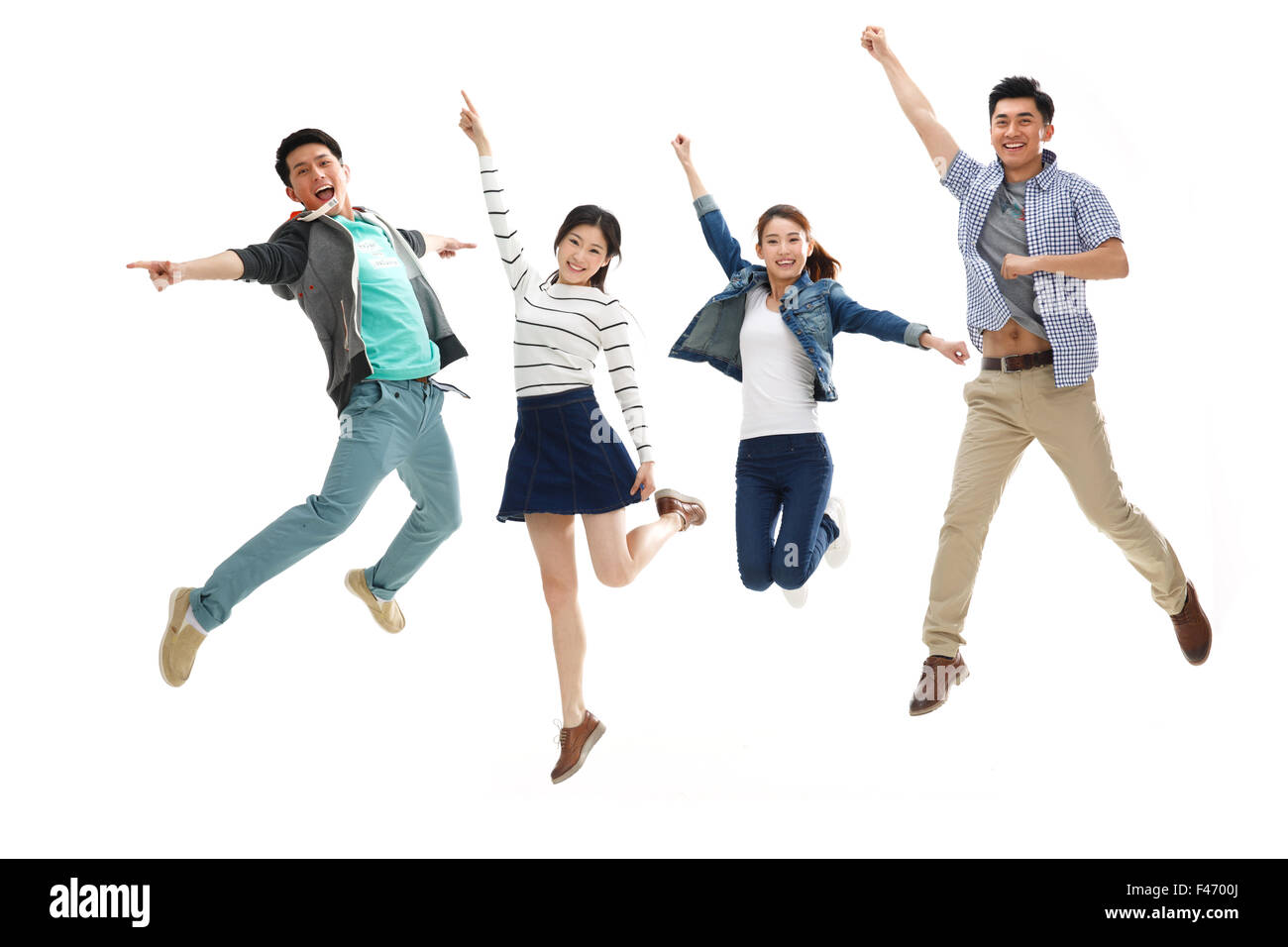 Portrait of four young people jumping Stock Photo - Alamy