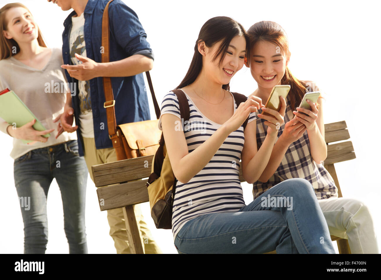 Young people using smart phone Stock Photo - Alamy
