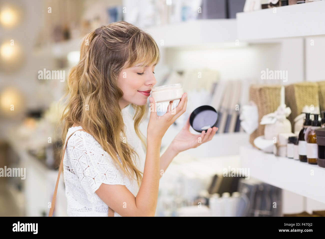 Beautiful customer smelling product Stock Photo - Alamy