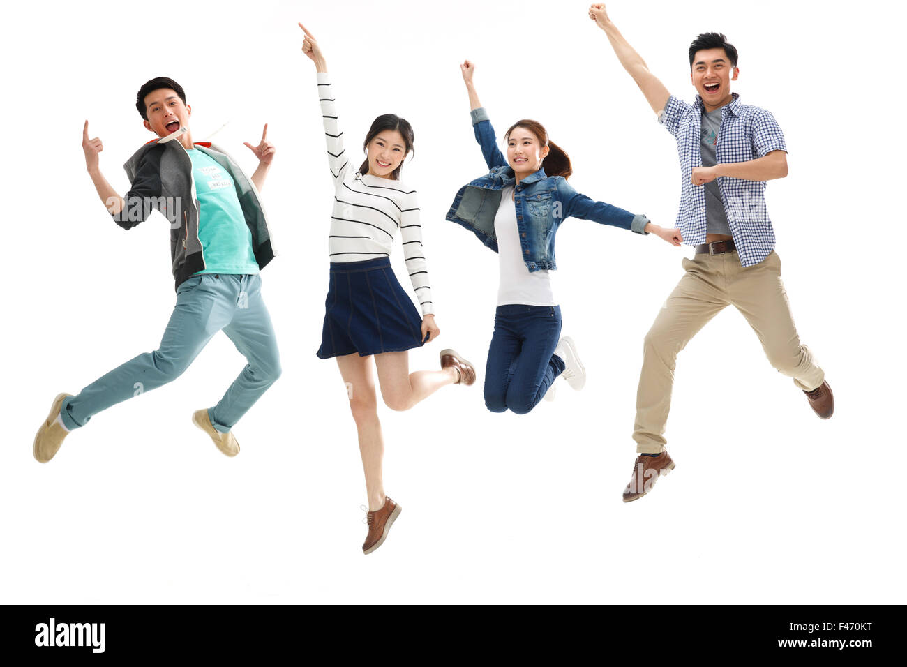 Portrait of four young people jumping Stock Photo - Alamy