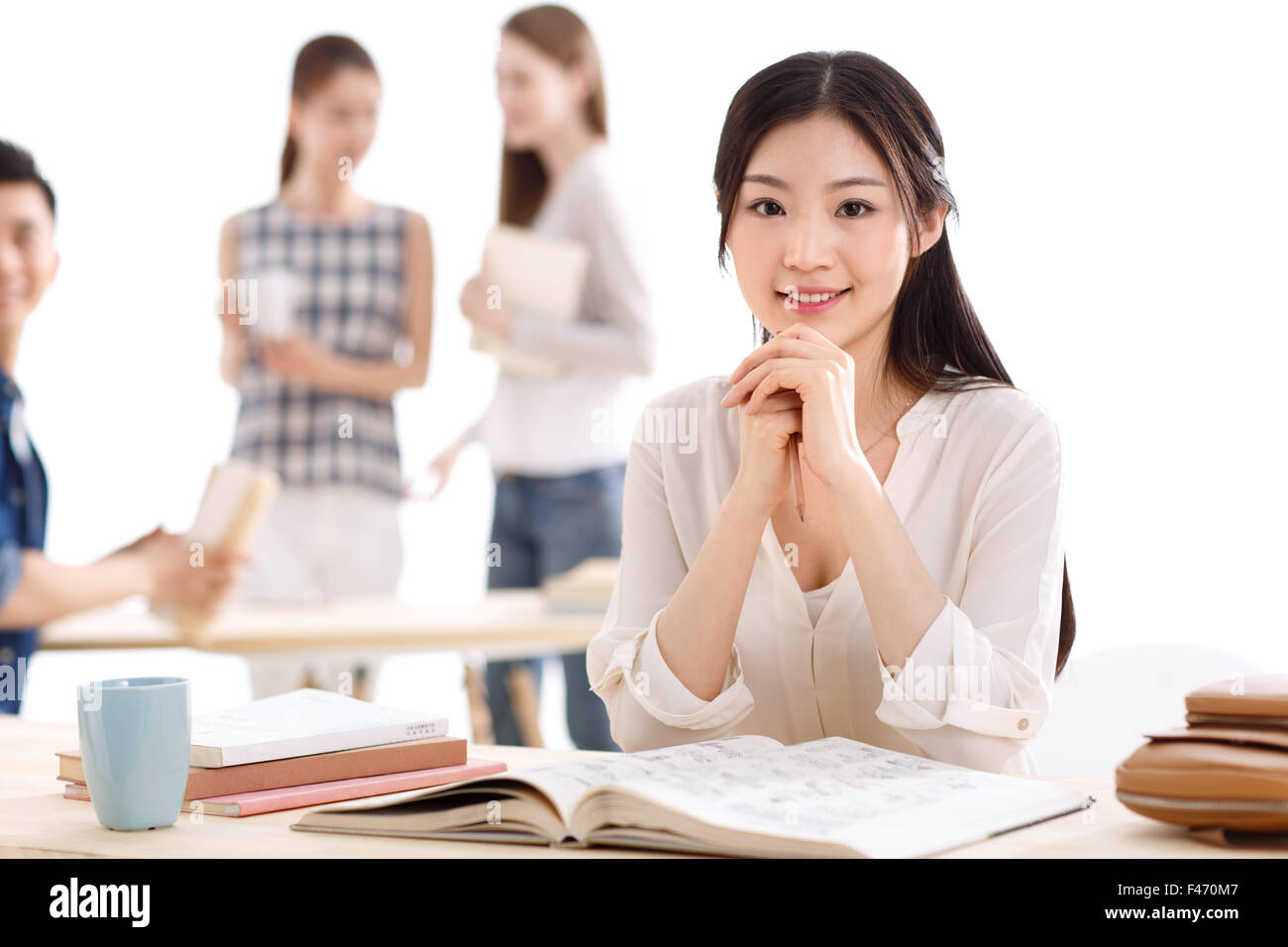 Young woman studying in classroom Stock Photo - Alamy