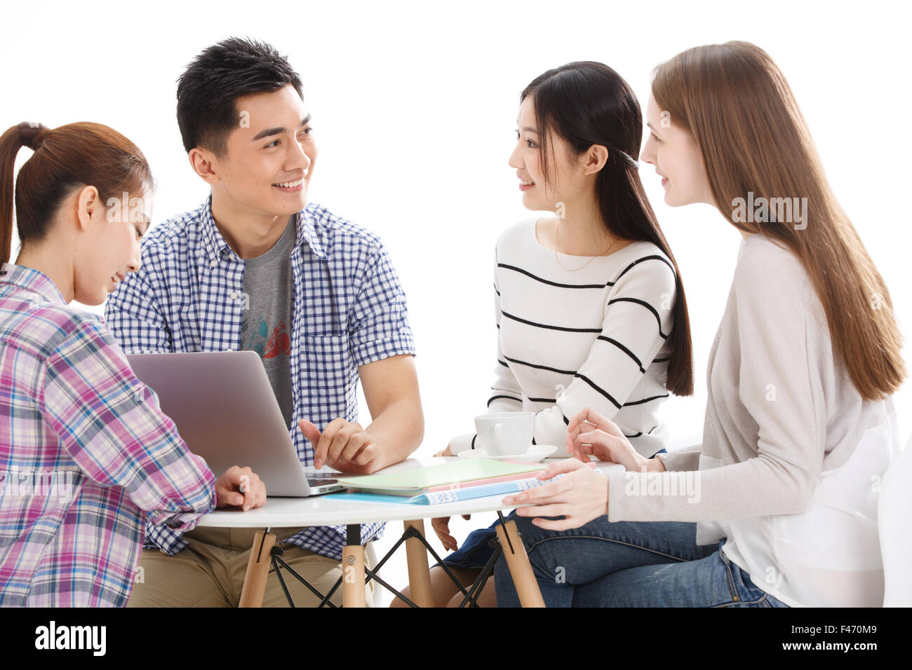 Young people around table Stock Photo - Alamy