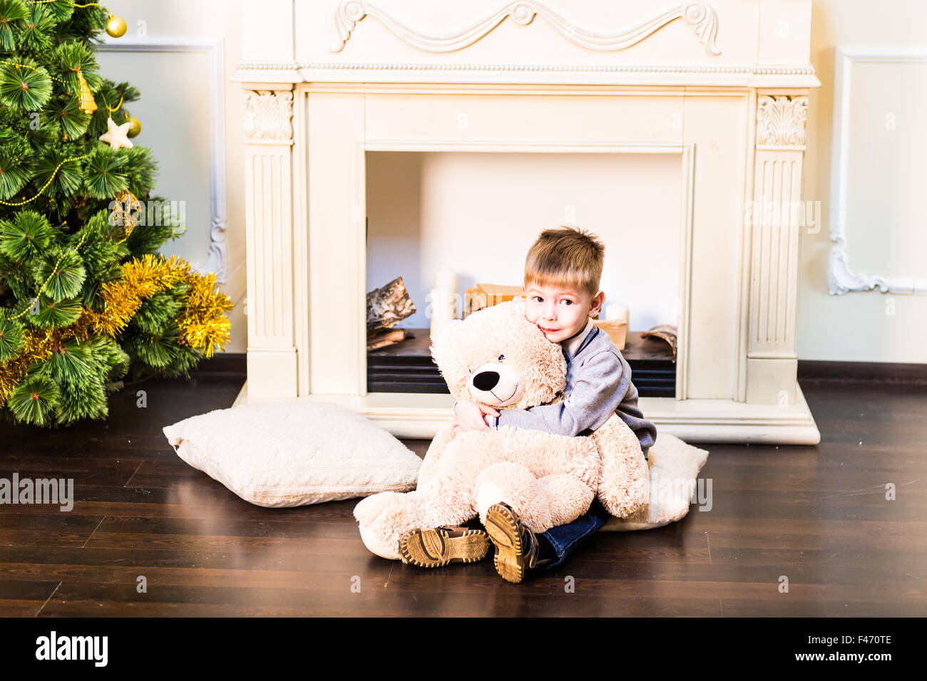 Portrait of cute boy with teddy bear near the christmas tree Stock ...