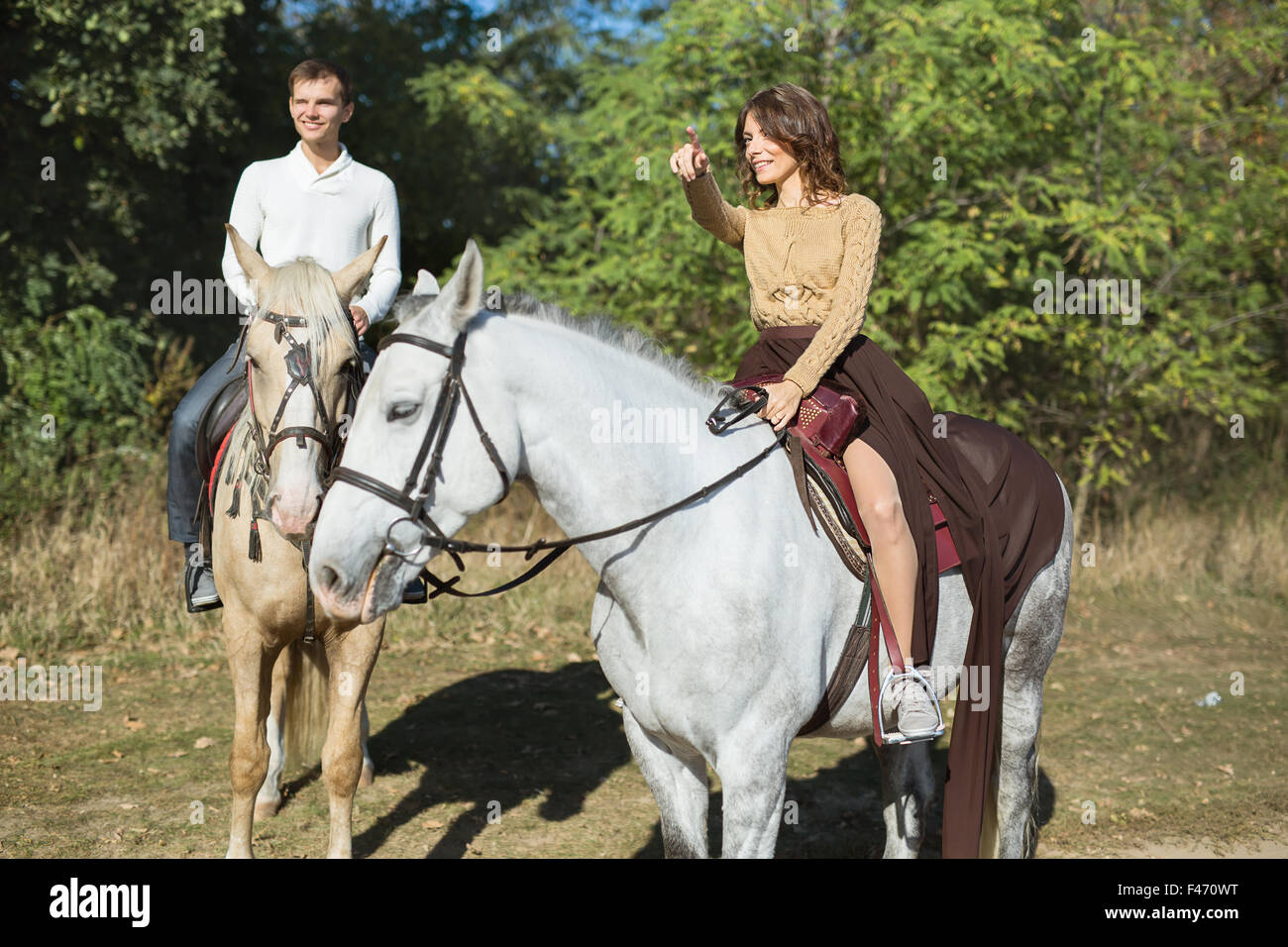 Young couple in love riding a horse Stock Photo - Alamy