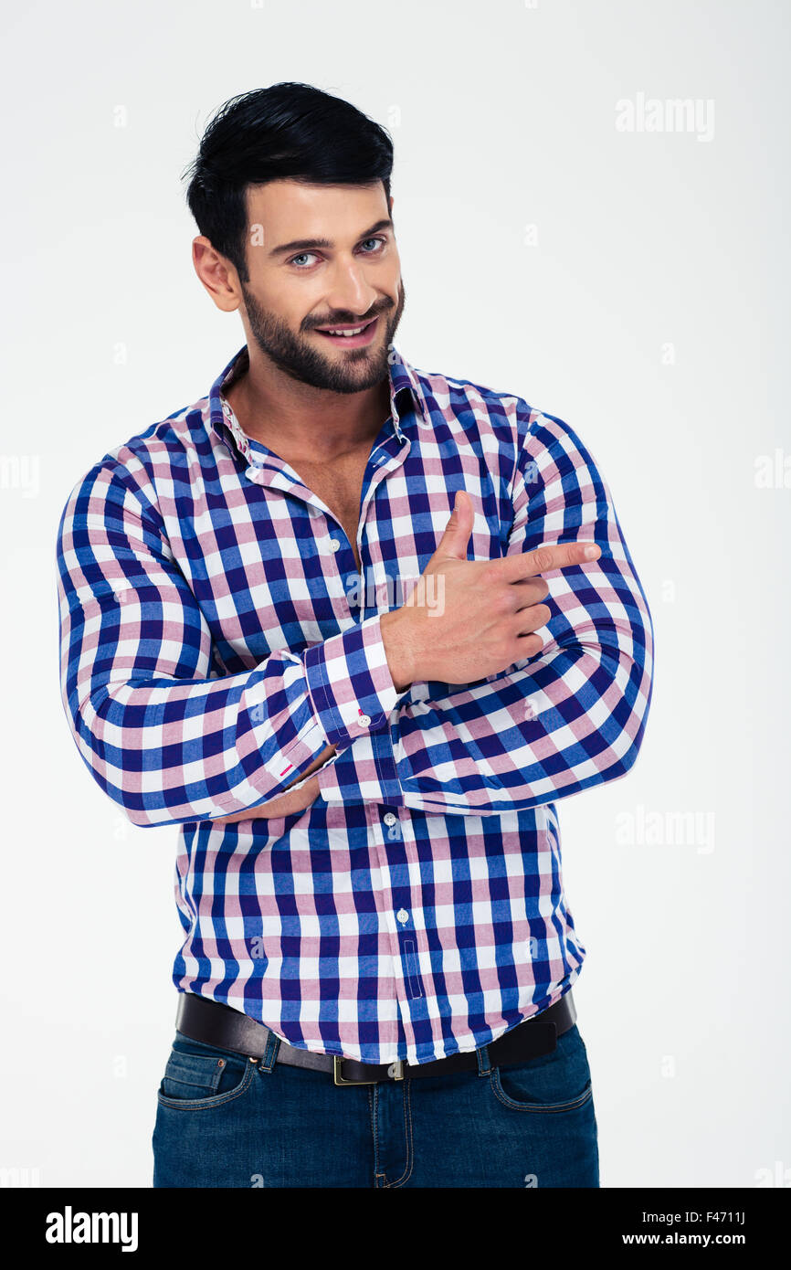 Portrait of a handsome man pointing finger away isolated on a white ...