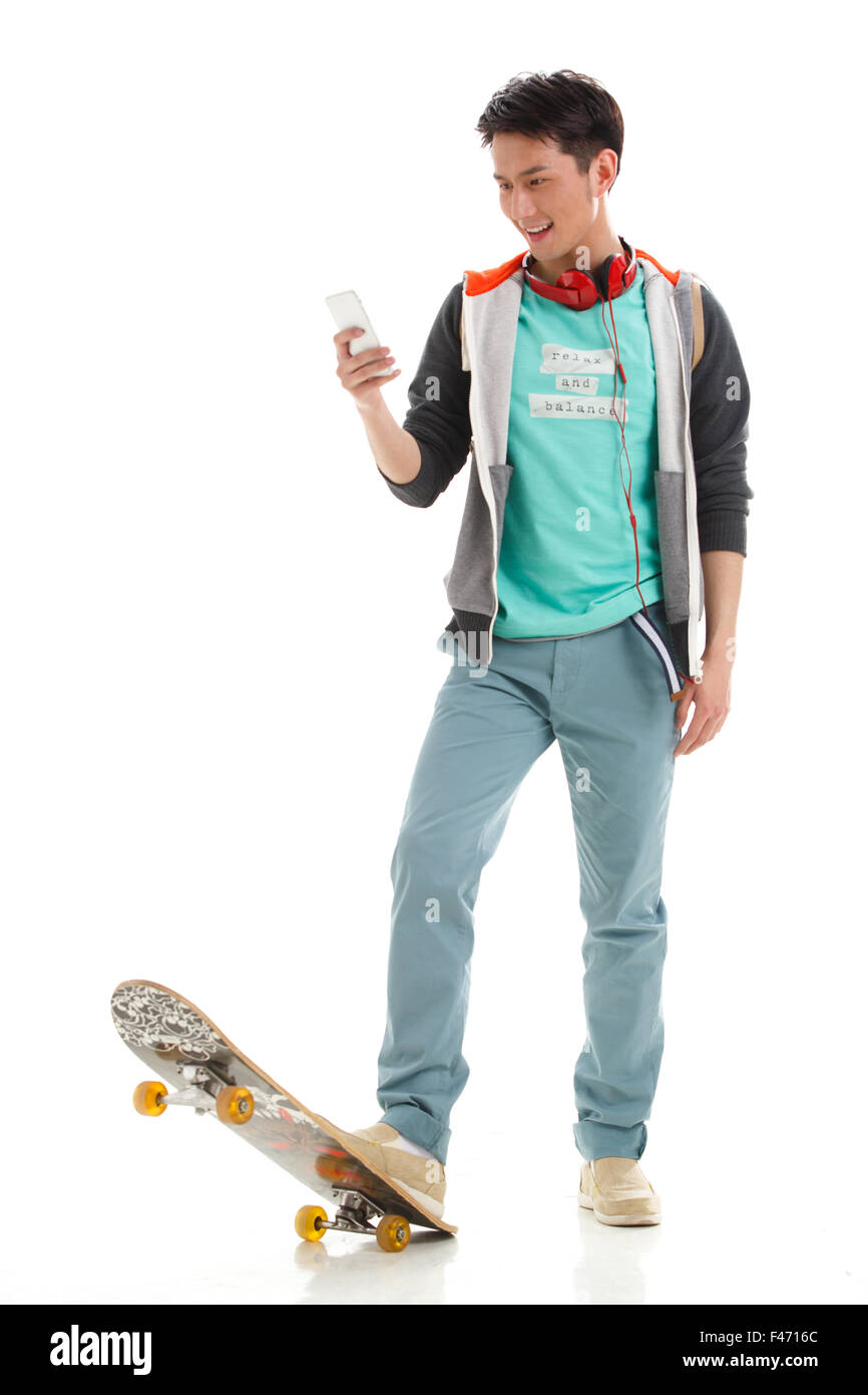 Young man using cellphone Stock Photo - Alamy