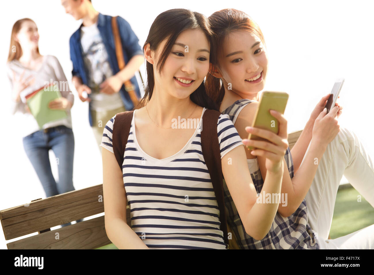Young people using smart phone Stock Photo - Alamy