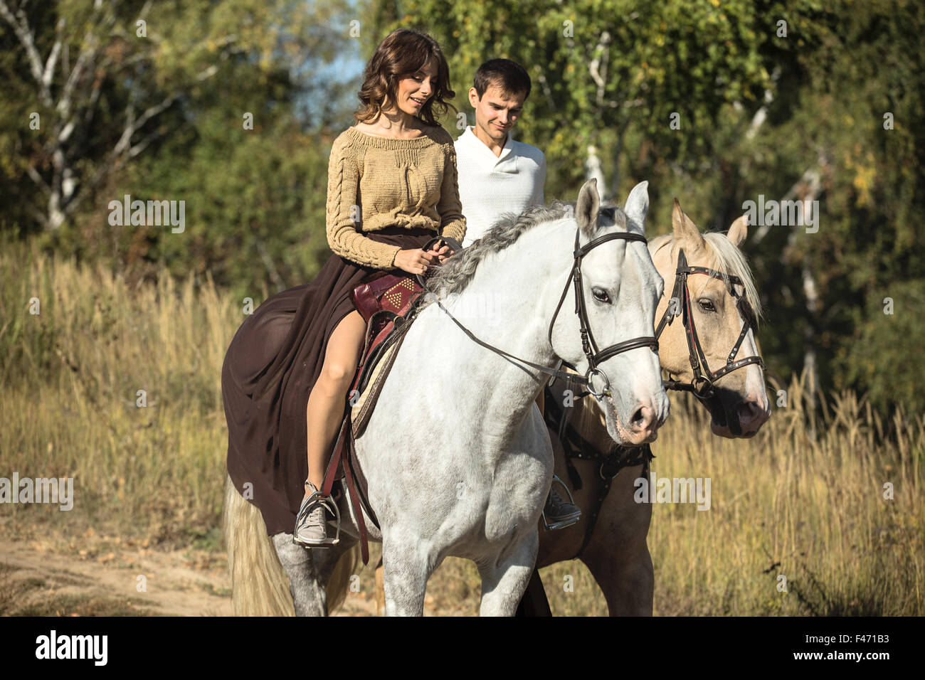 Young couple in love riding a horse Stock Photo - Alamy