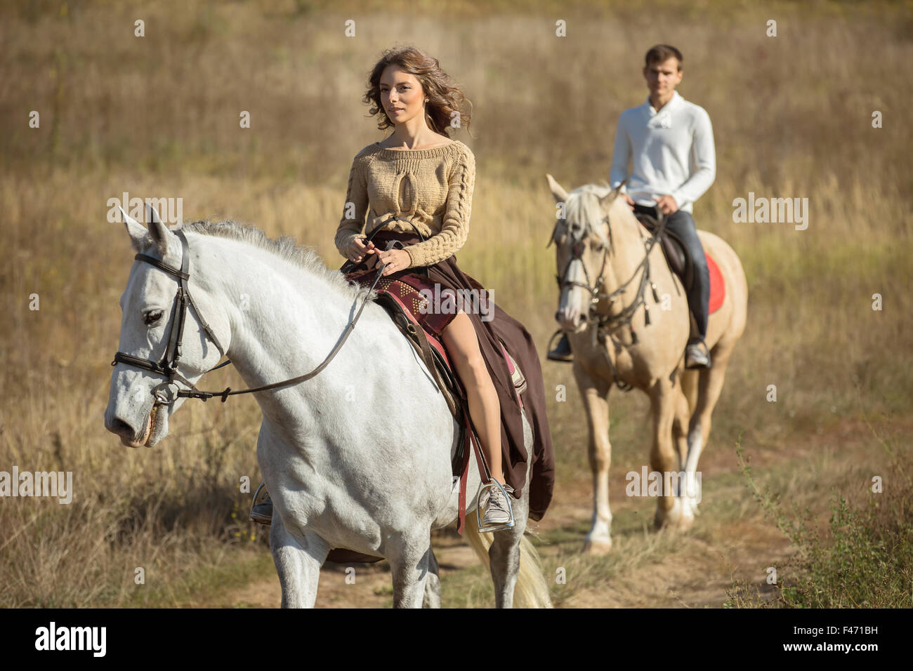 Young couple in love riding a horse Stock Photo - Alamy