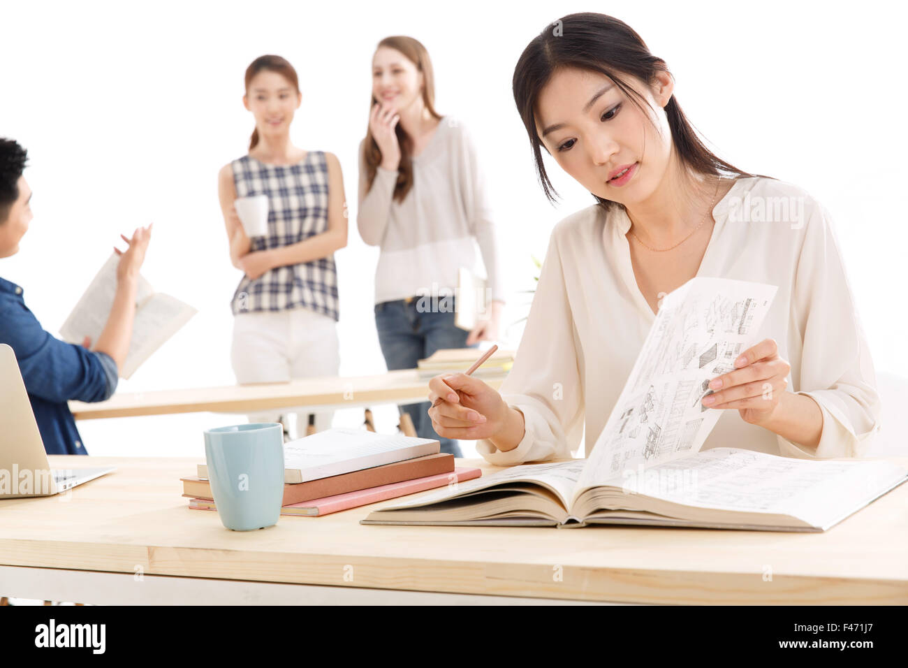 Young woman studying in classroom Stock Photo - Alamy