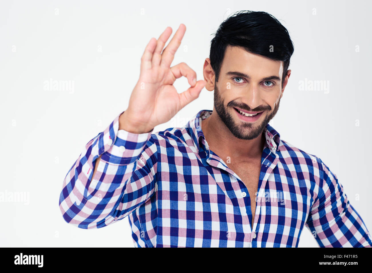 Portrait of a happy man showing ok sign with fingers isolated on a ...