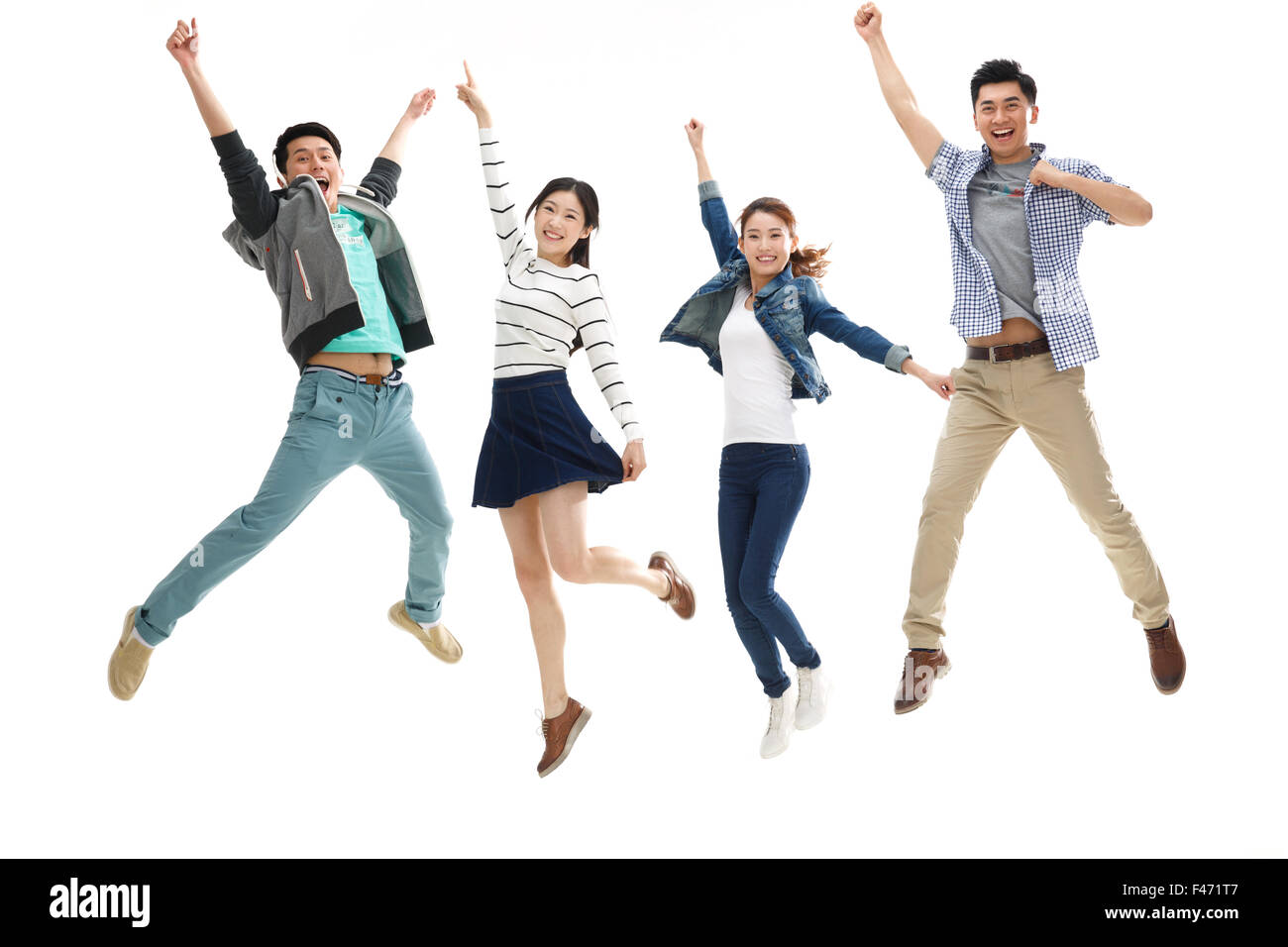 Portrait of four young people jumping Stock Photo - Alamy