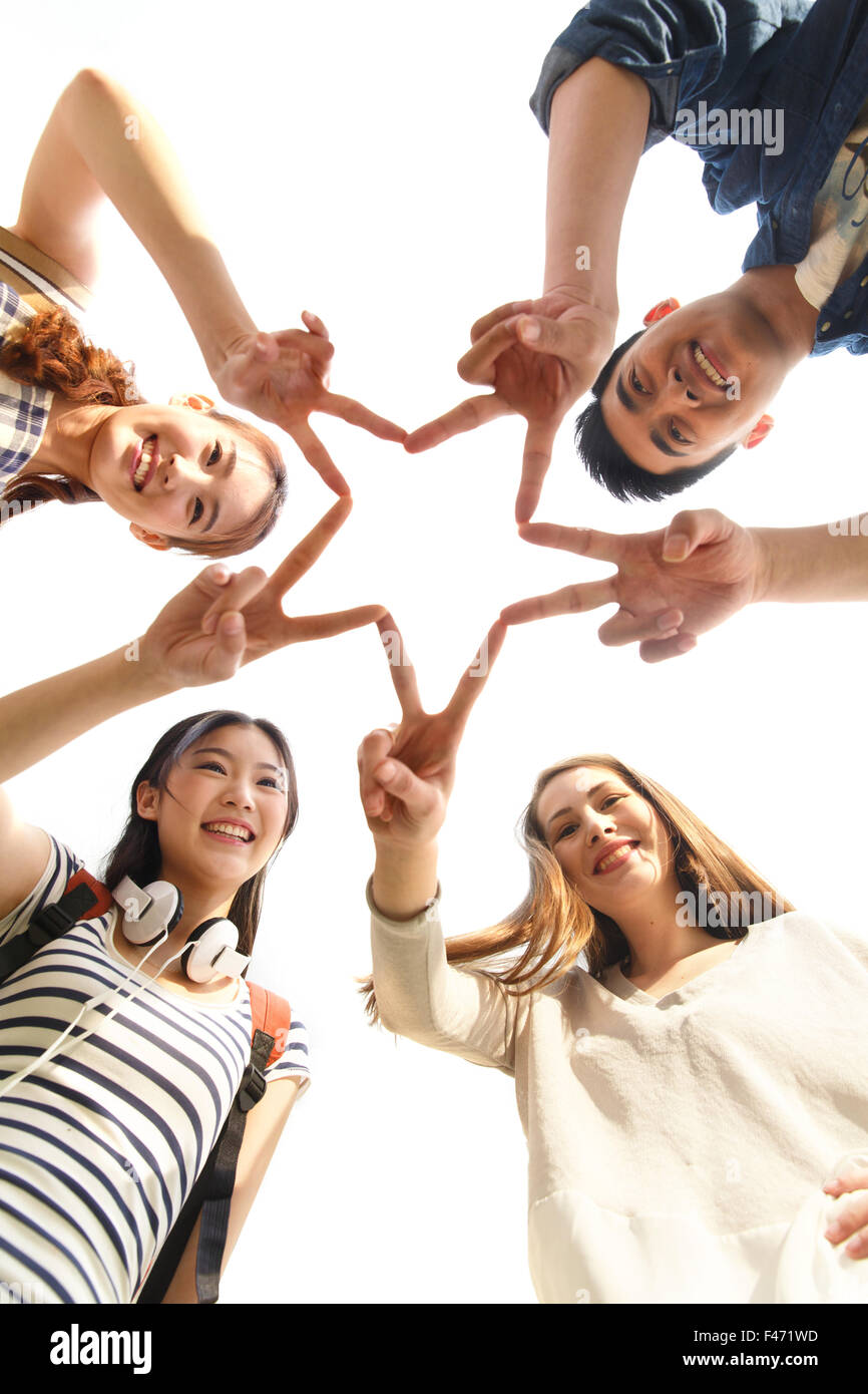 Young people in circle with hands together Stock Photo - Alamy