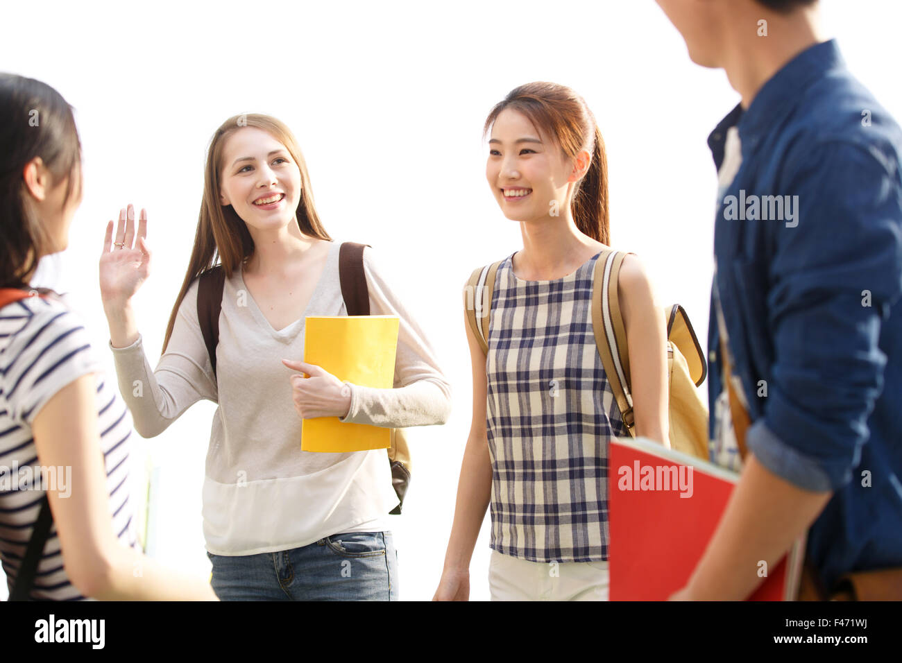 Four young people talking Stock Photo - Alamy