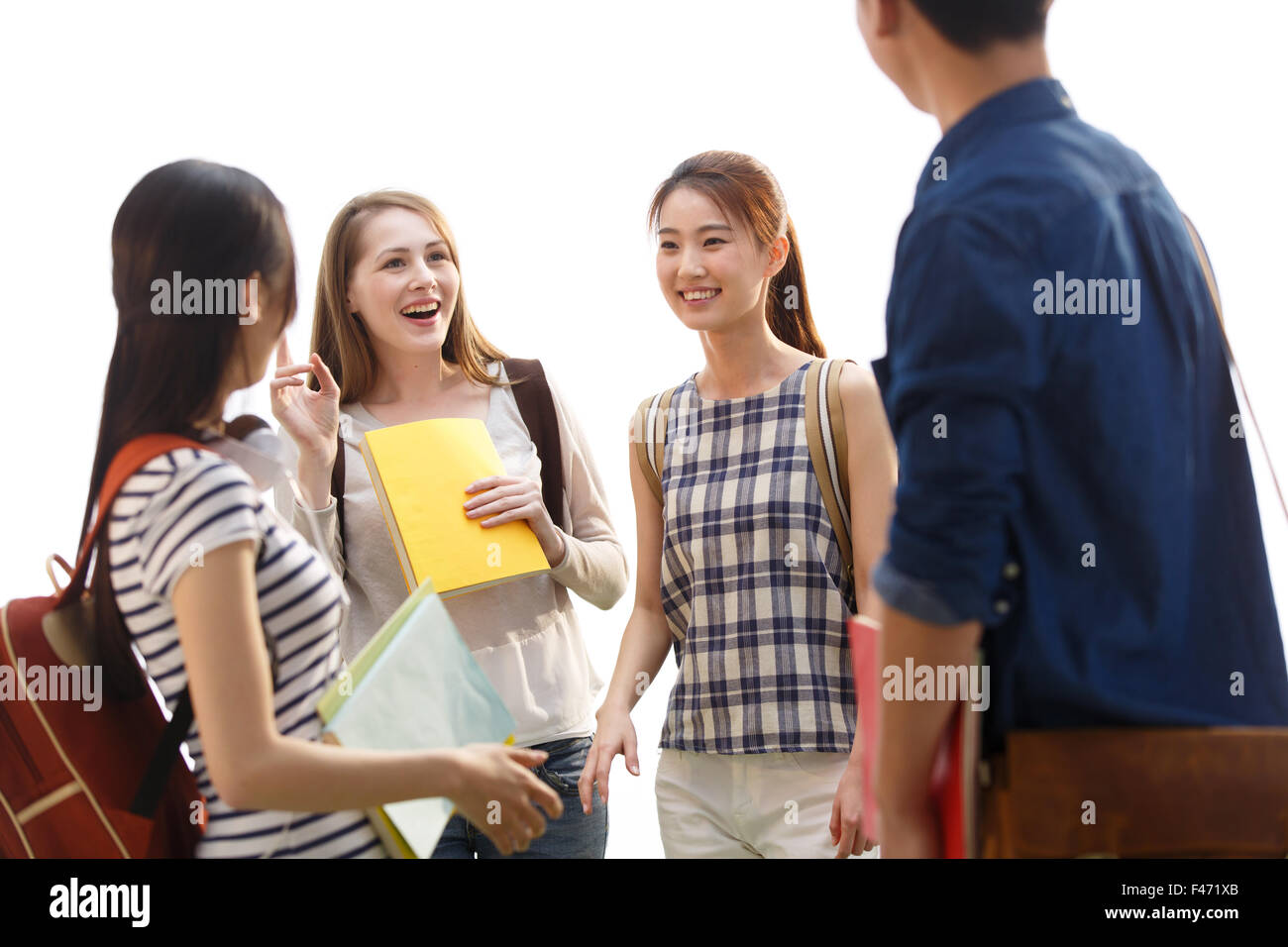Four young people talking Stock Photo - Alamy