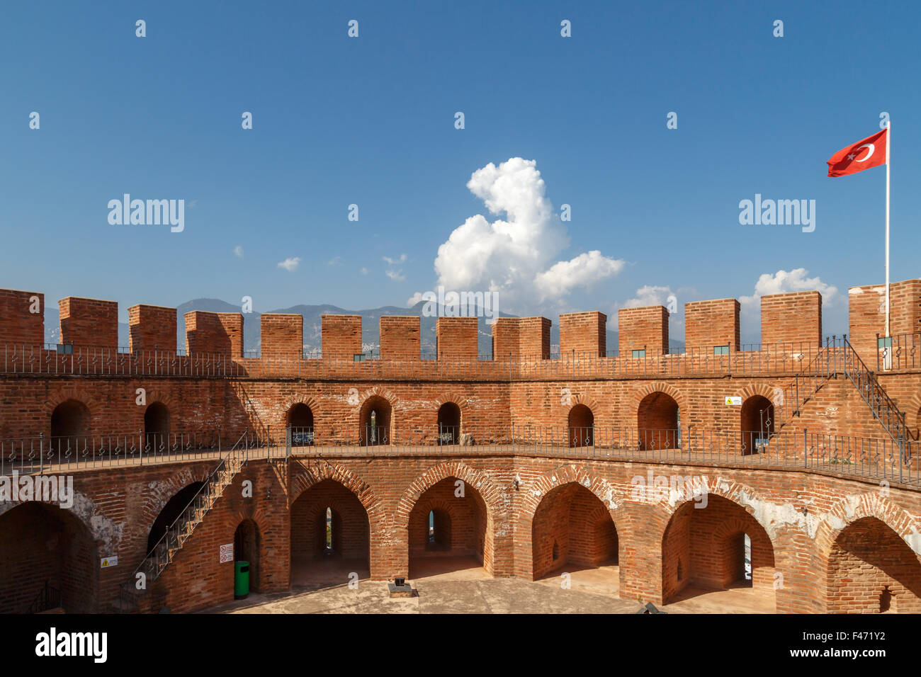 View of Alanya Red Tower in Antalya with orenge bricks, on bright blue ...