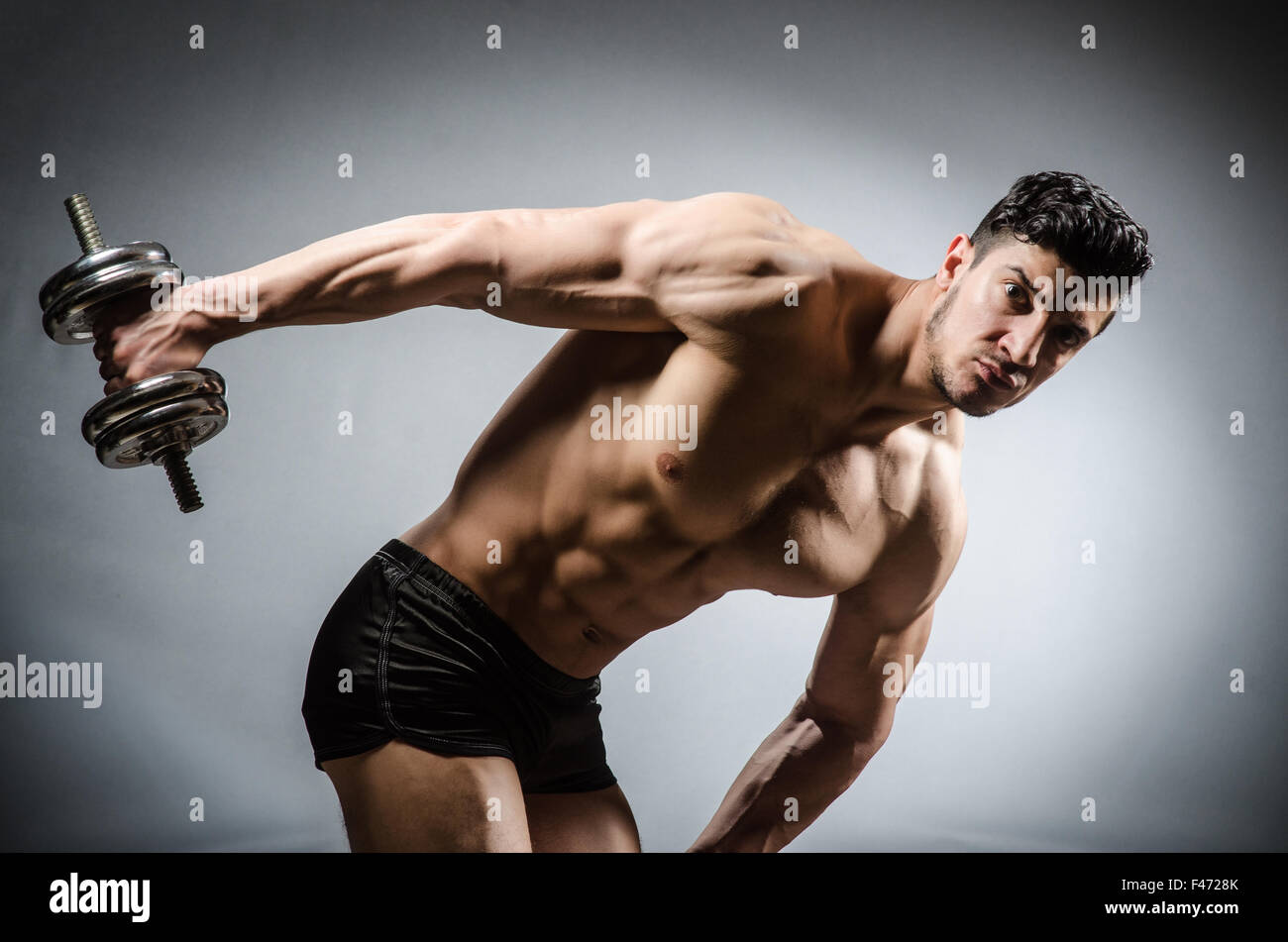 Muscular ripped bodybuilder with dumbbells Stock Photo - Alamy