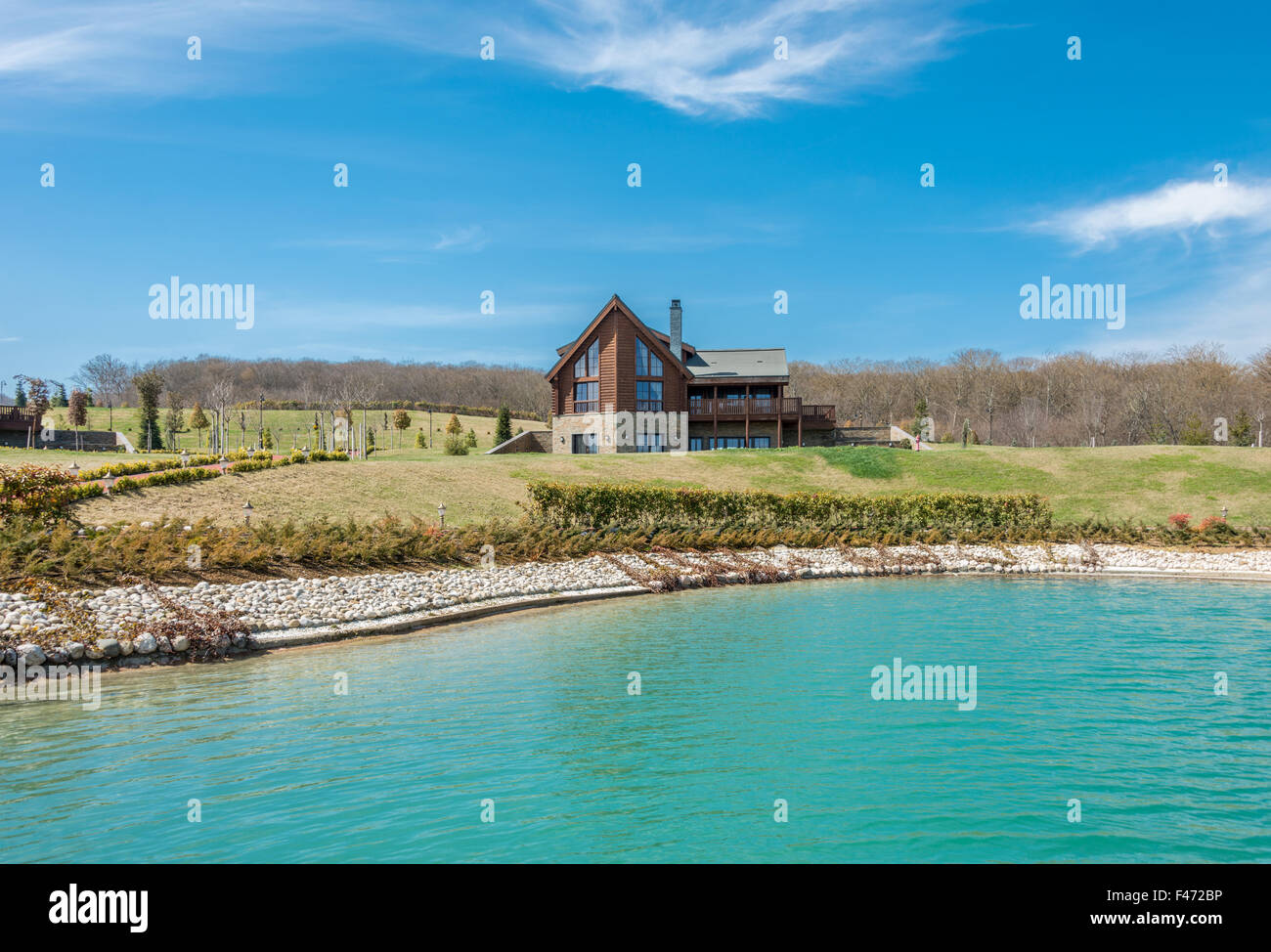 Modern house near water on bright day Stock Photo - Alamy