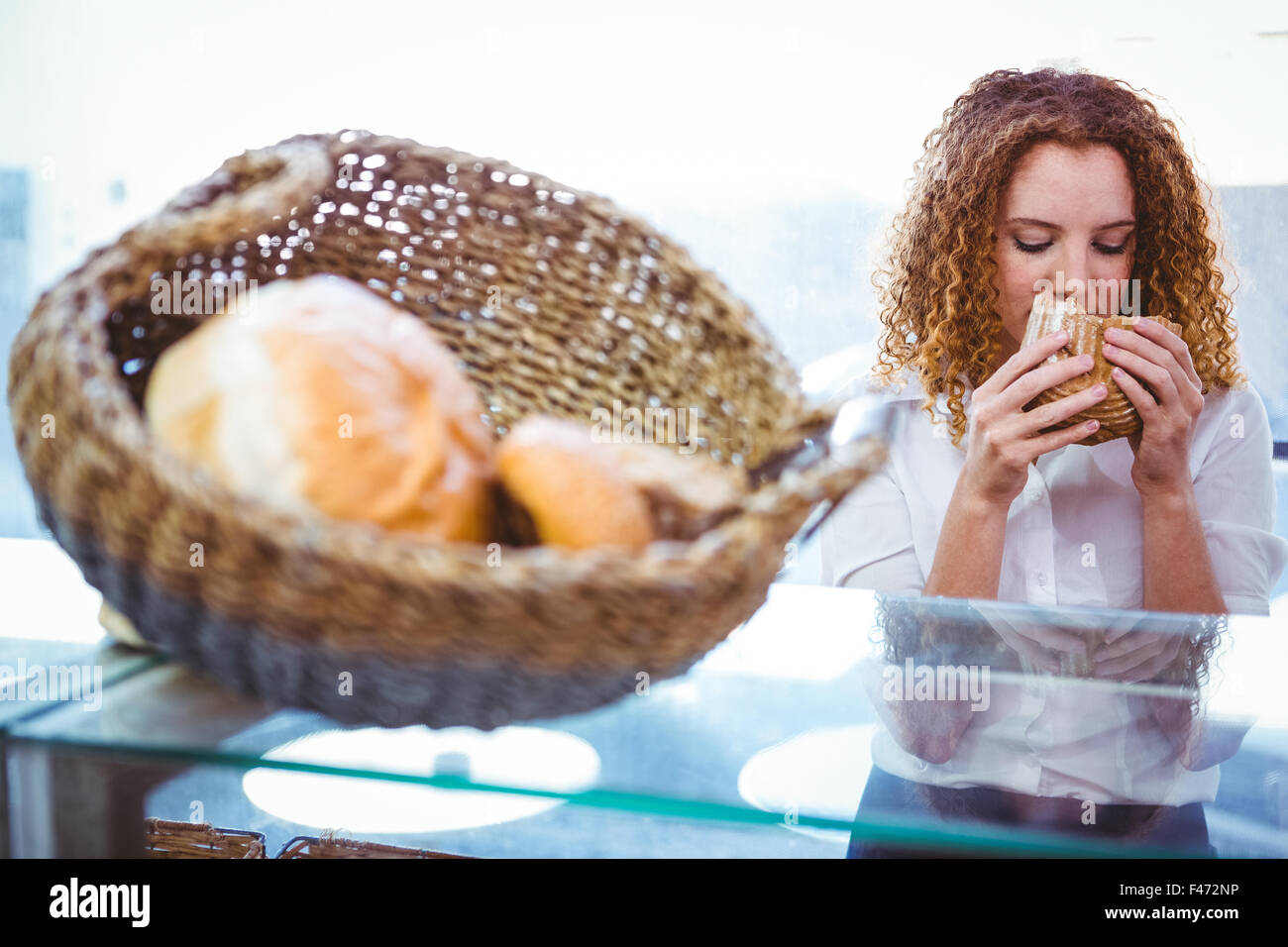 A pretty barista smelling bread Stock Photo - Alamy