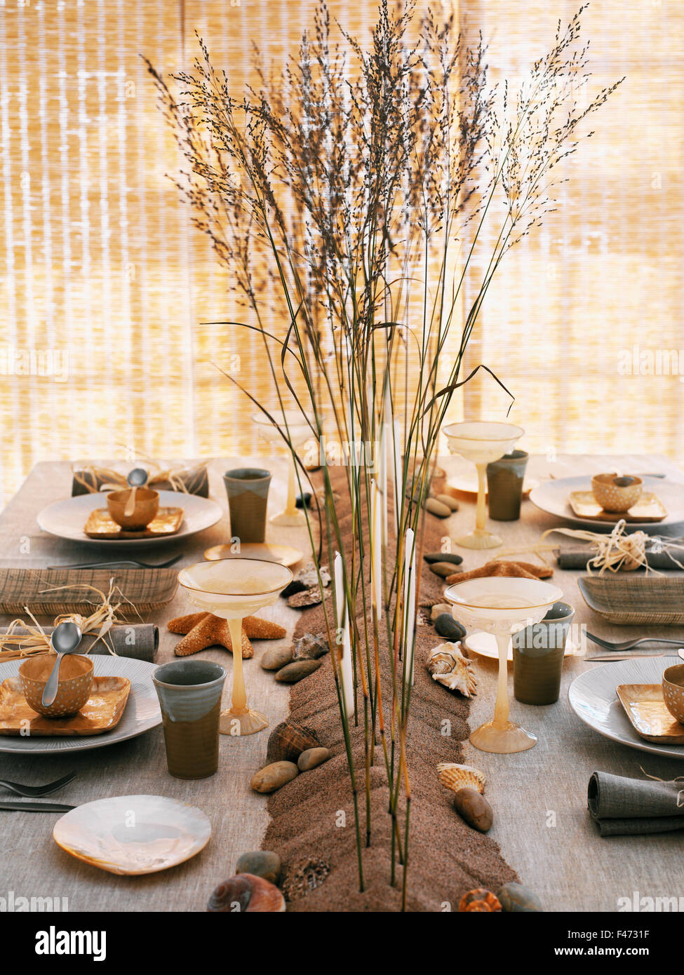 A set table decorated with sand Stock Photo - Alamy