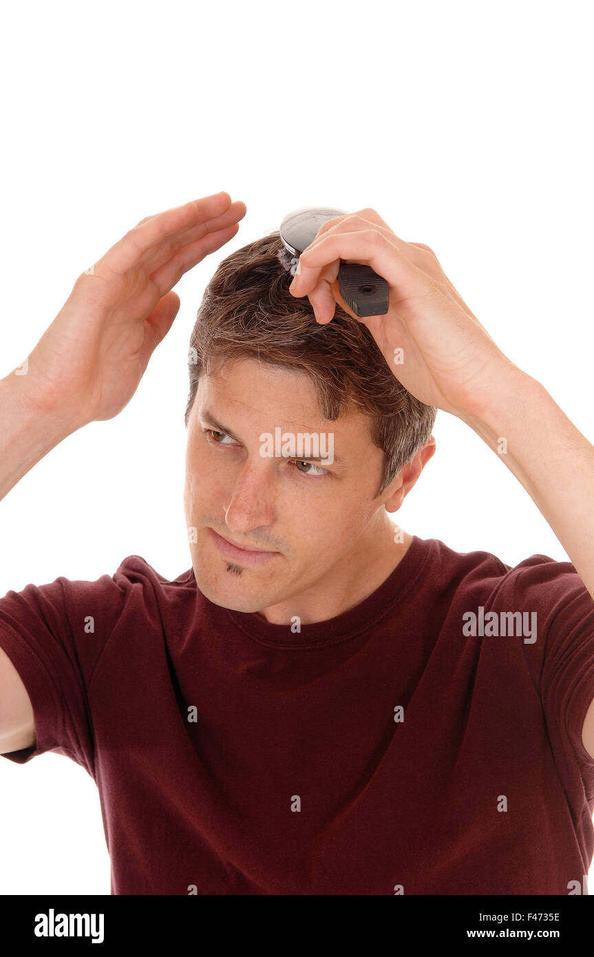 Man brushing his hair Stock Photo - Alamy