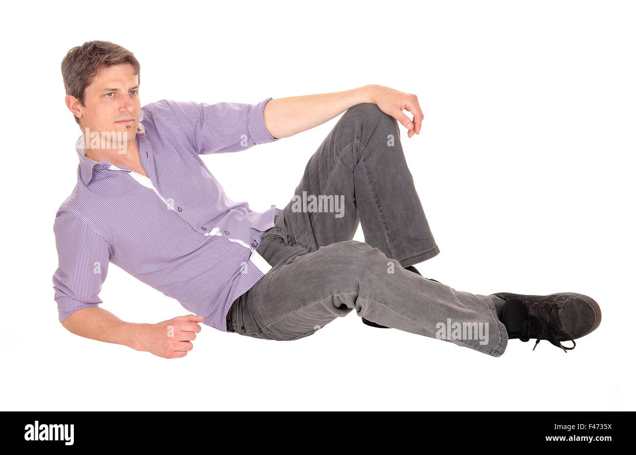 Young man sitting on floor Stock Photo - Alamy