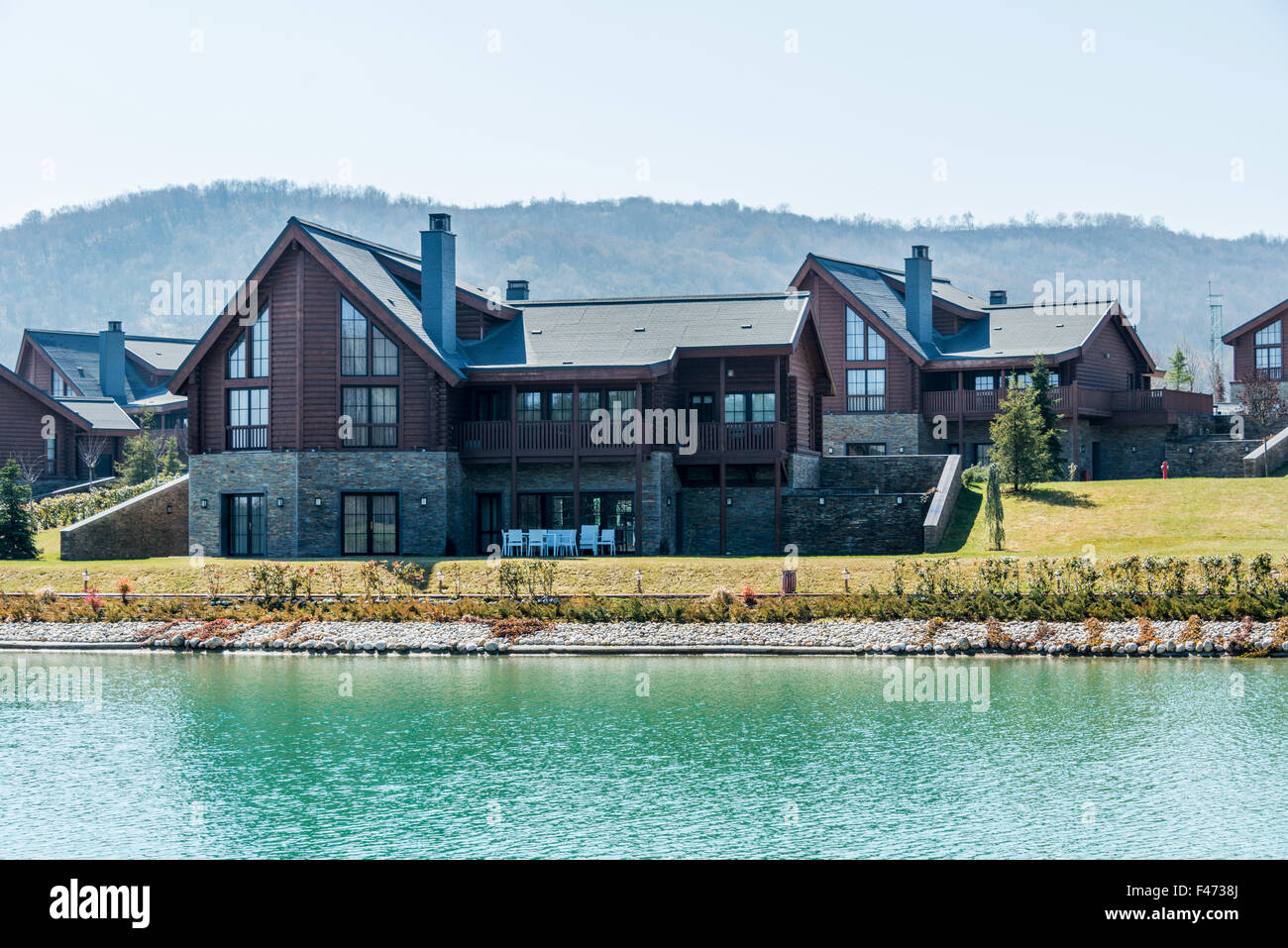Modern house near water on bright day Stock Photo - Alamy
