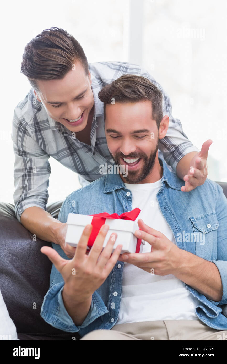 Homosexual couple men receiving a gift Stock Photo - Alamy