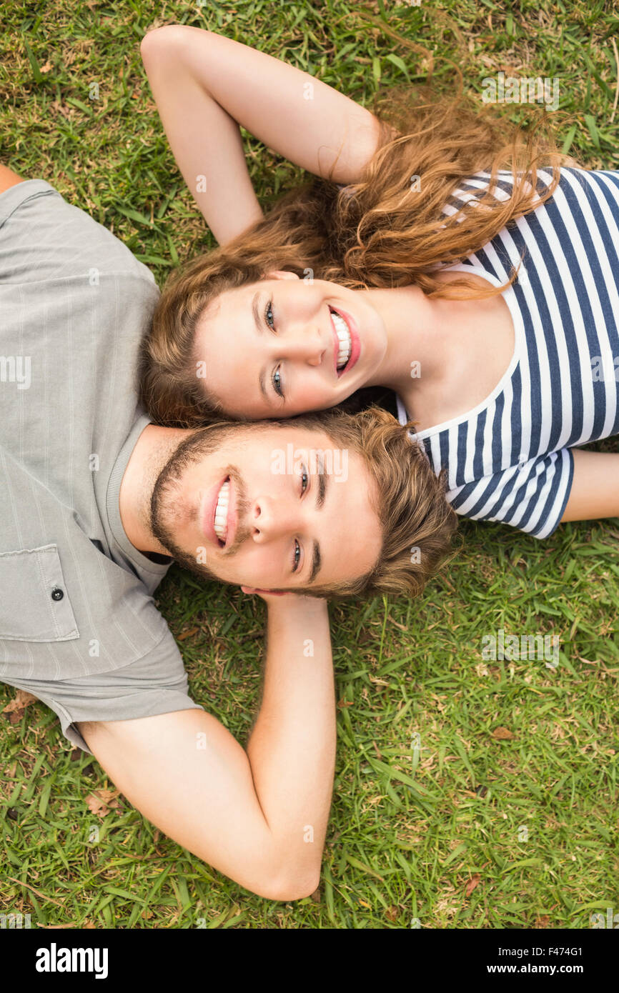 Cute couple relaxing in the grass in the park Stock Photo - Alamy