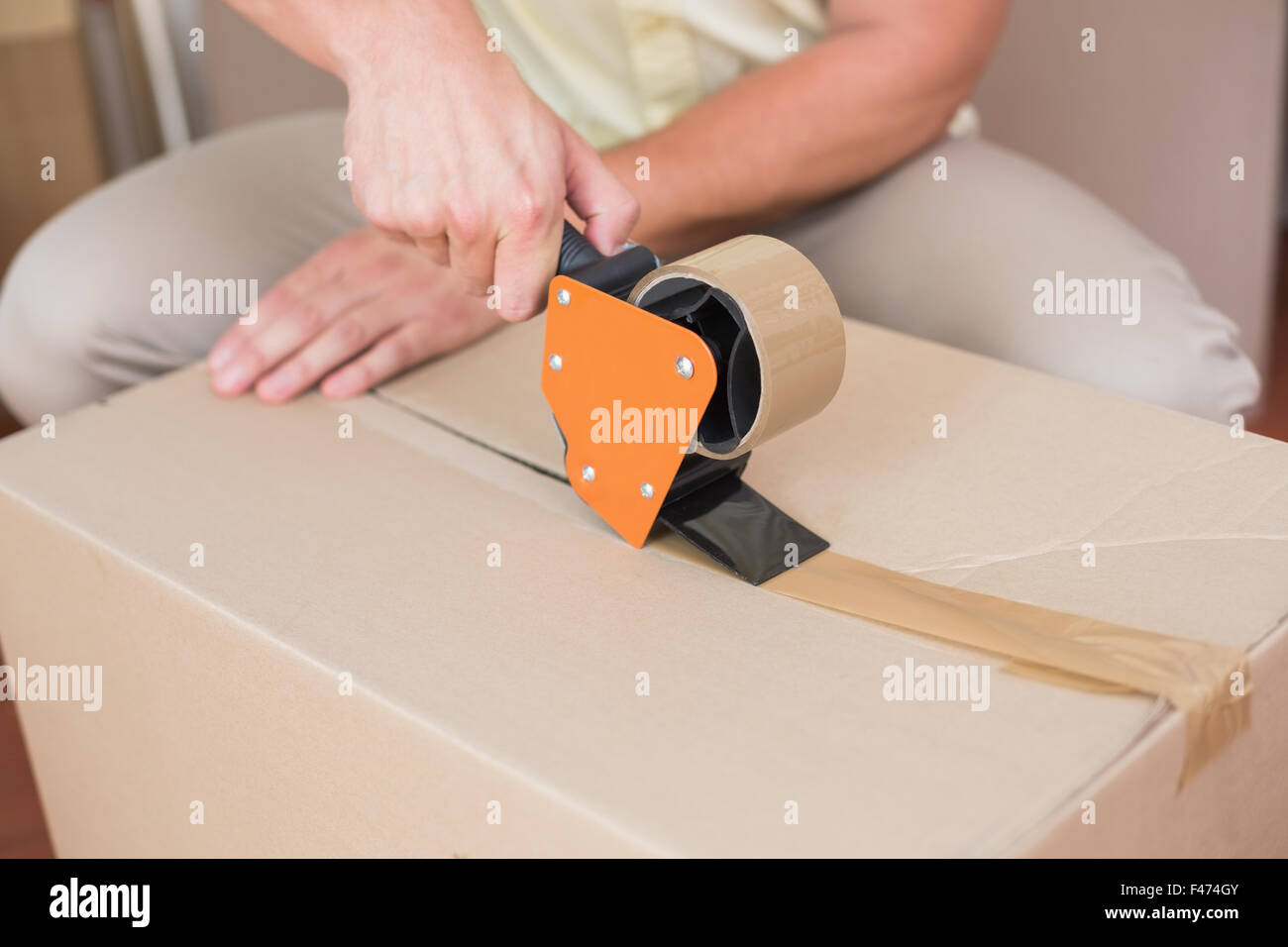Caucasian man taping cardboard box hi-res stock photography and images ...