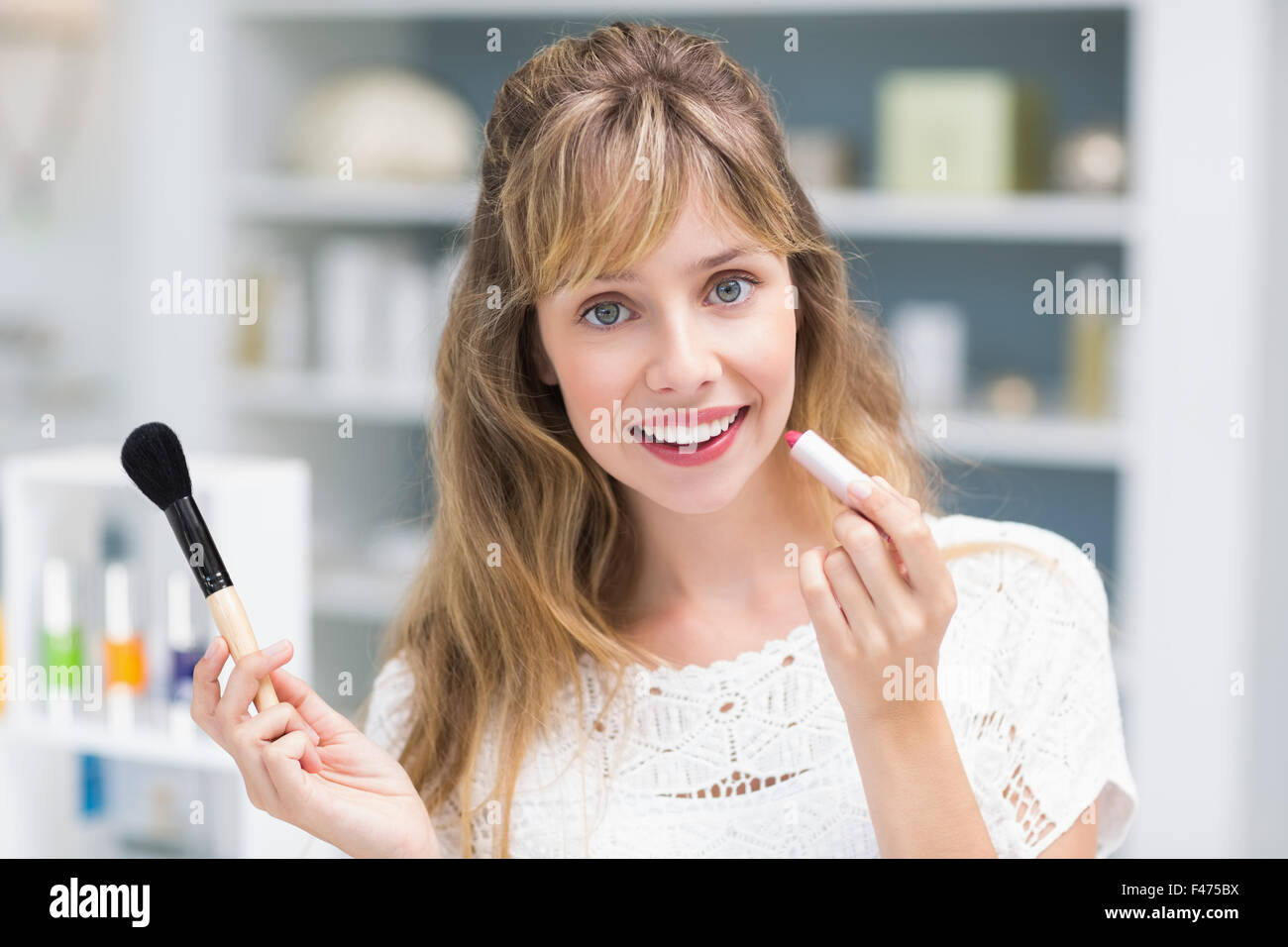 Beautiful costumer putting on makeup Stock Photo - Alamy