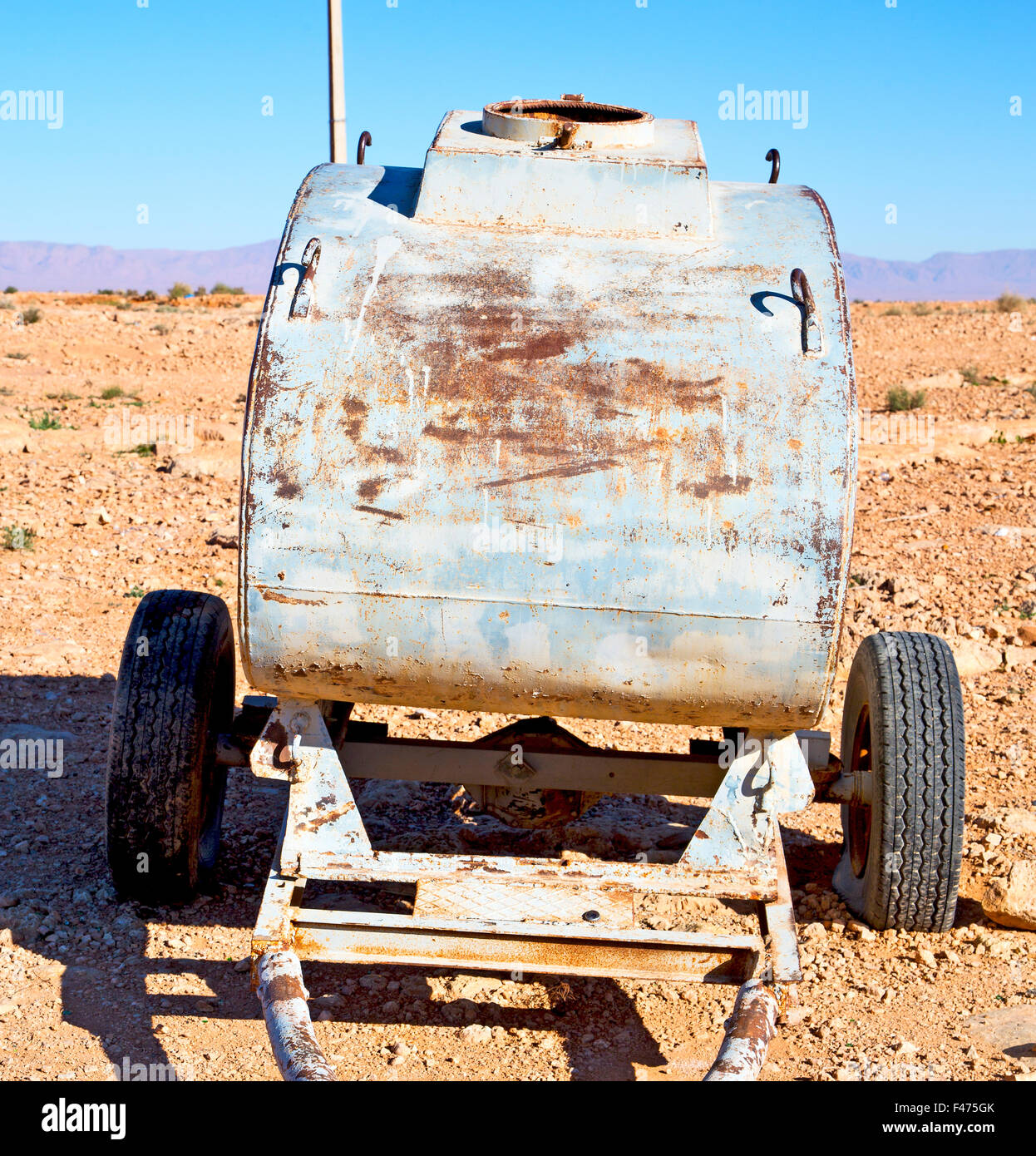water tank in morocco africa land gray metal weel and arid Stock Photo ...