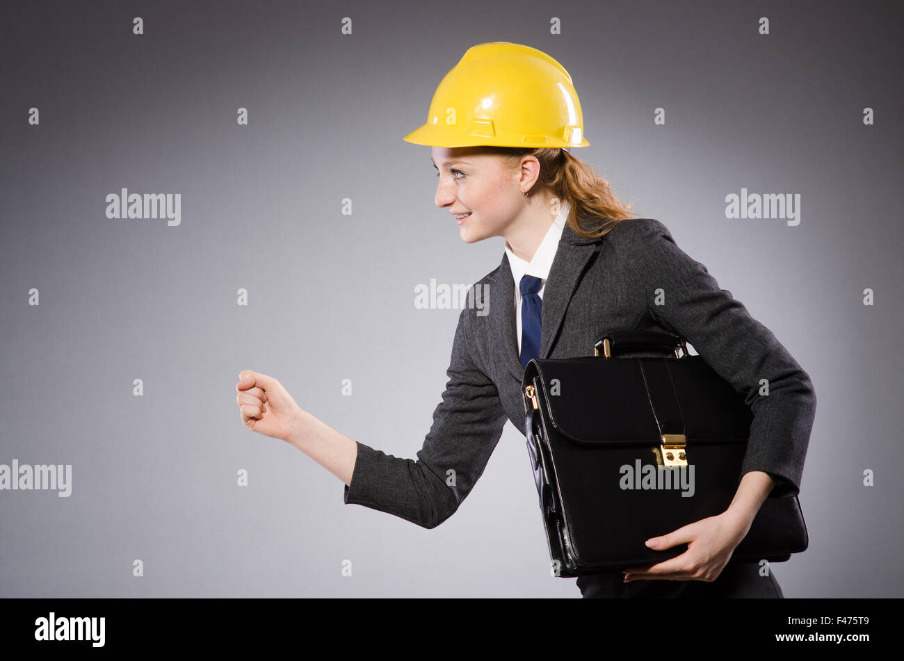Female engineer with helmet isolated on gray Stock Photo - Alamy
