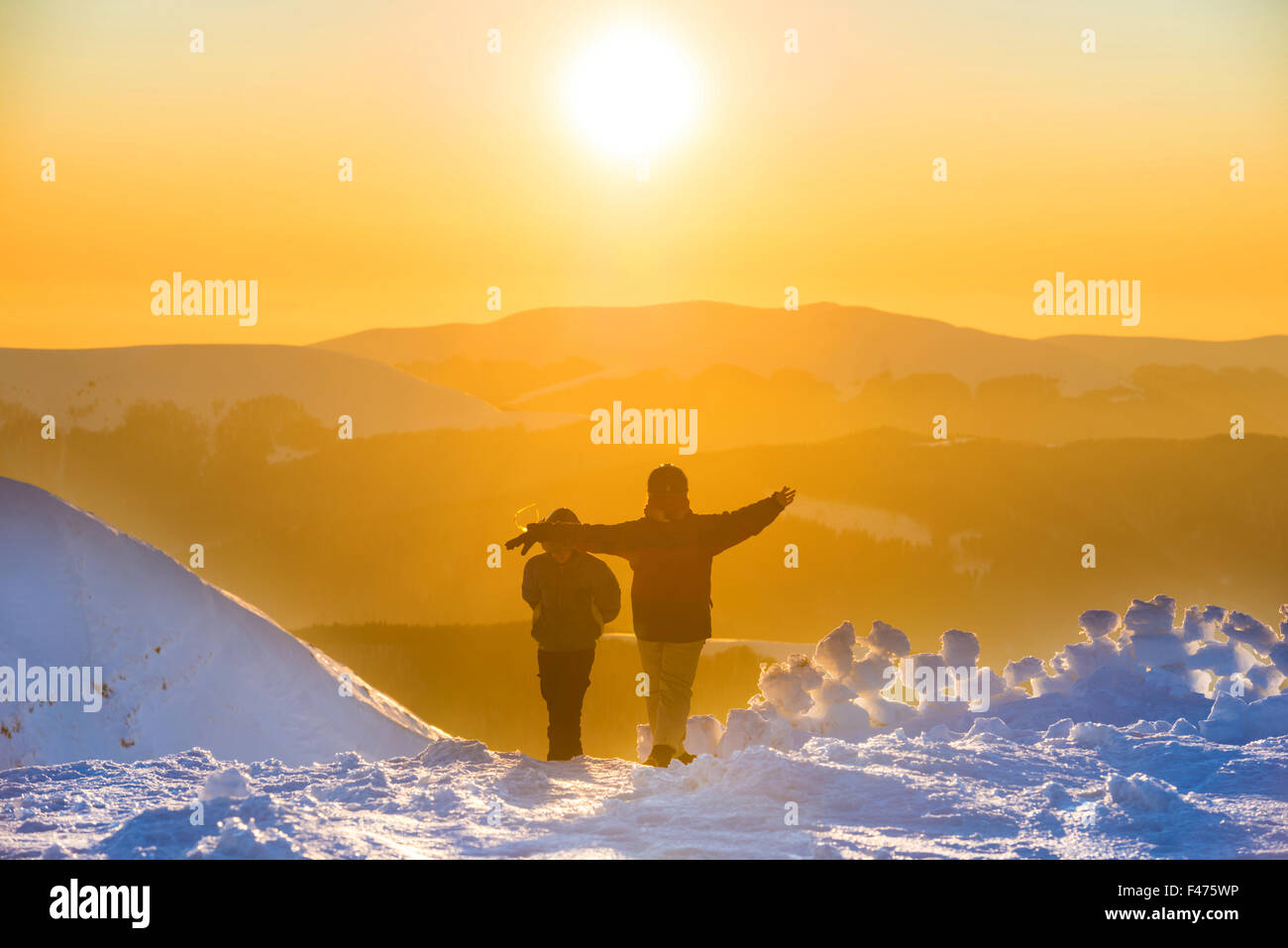 People walking at sunset in winter mountains Stock Photo - Alamy