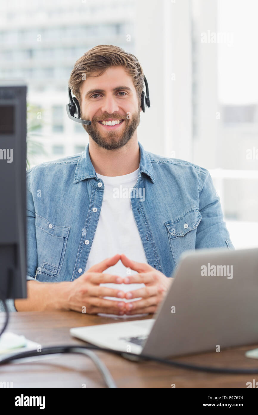 Happy operator with earpiece Stock Photo - Alamy